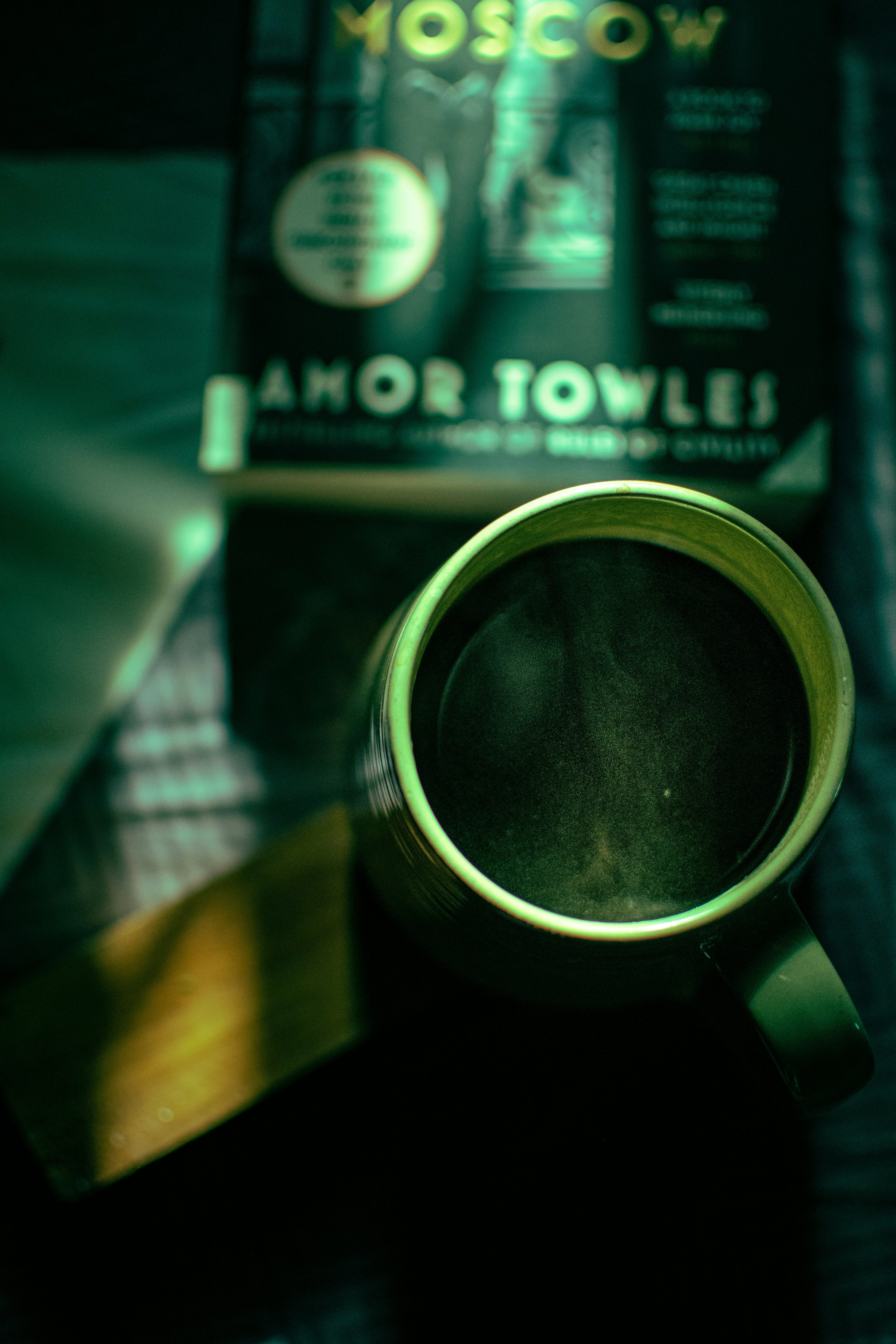 Emerald Rim: A Green Mug Anchored by a Neon-Poster Backdrop