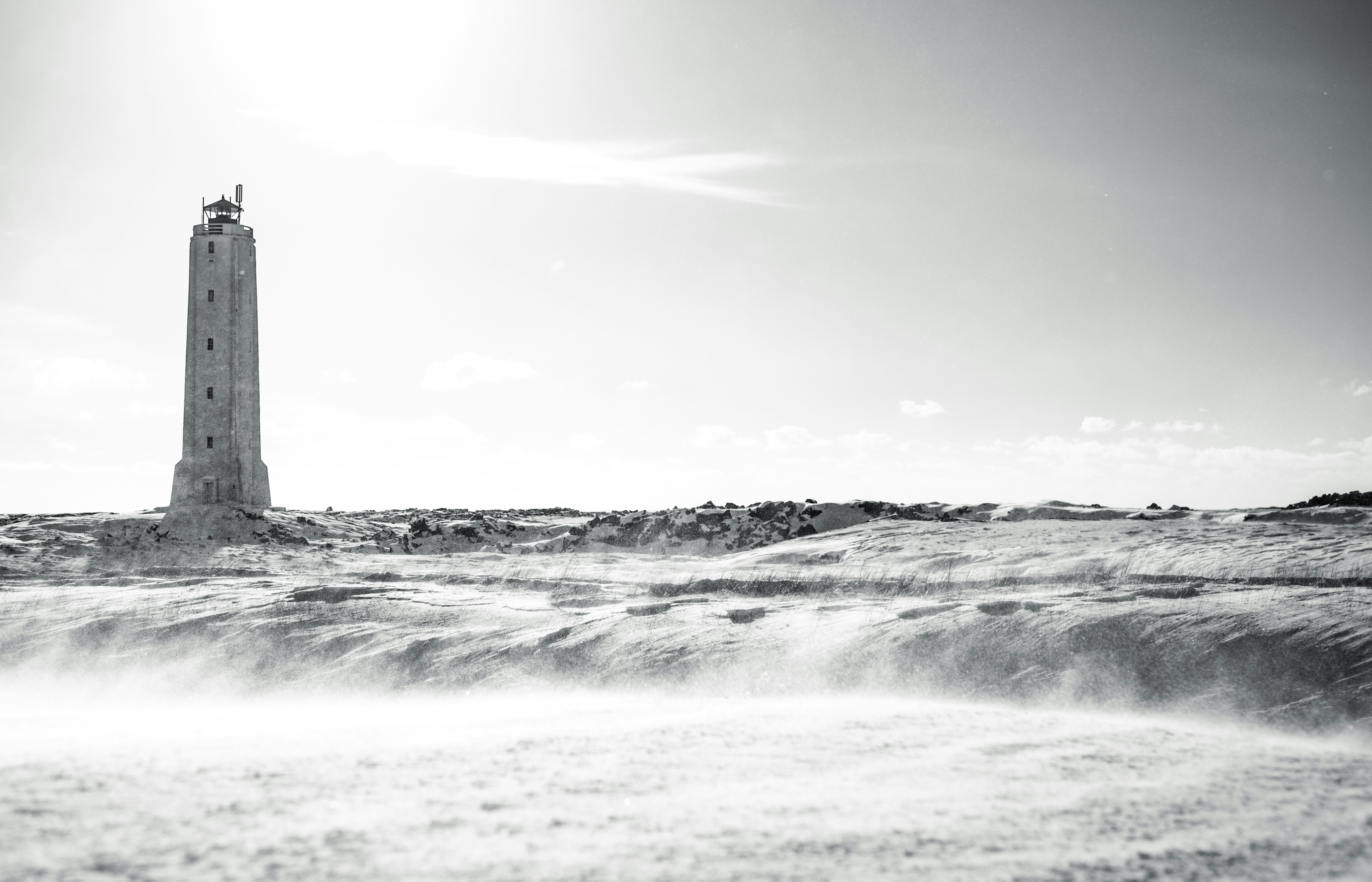 Lone Lighthouse at the Edge: Monochrome Sea in Quiet Motion