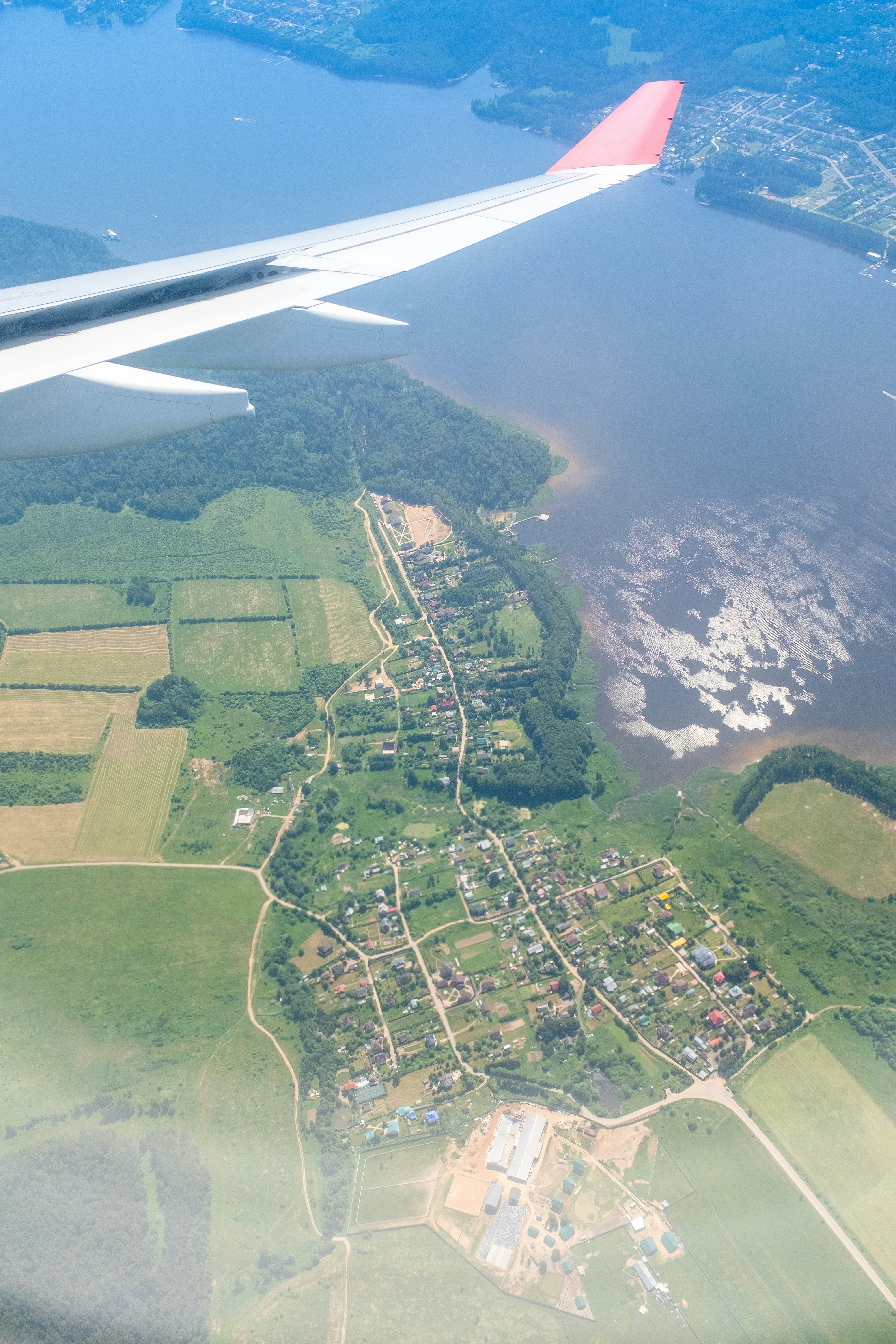 an aerial view of a small town and a lake