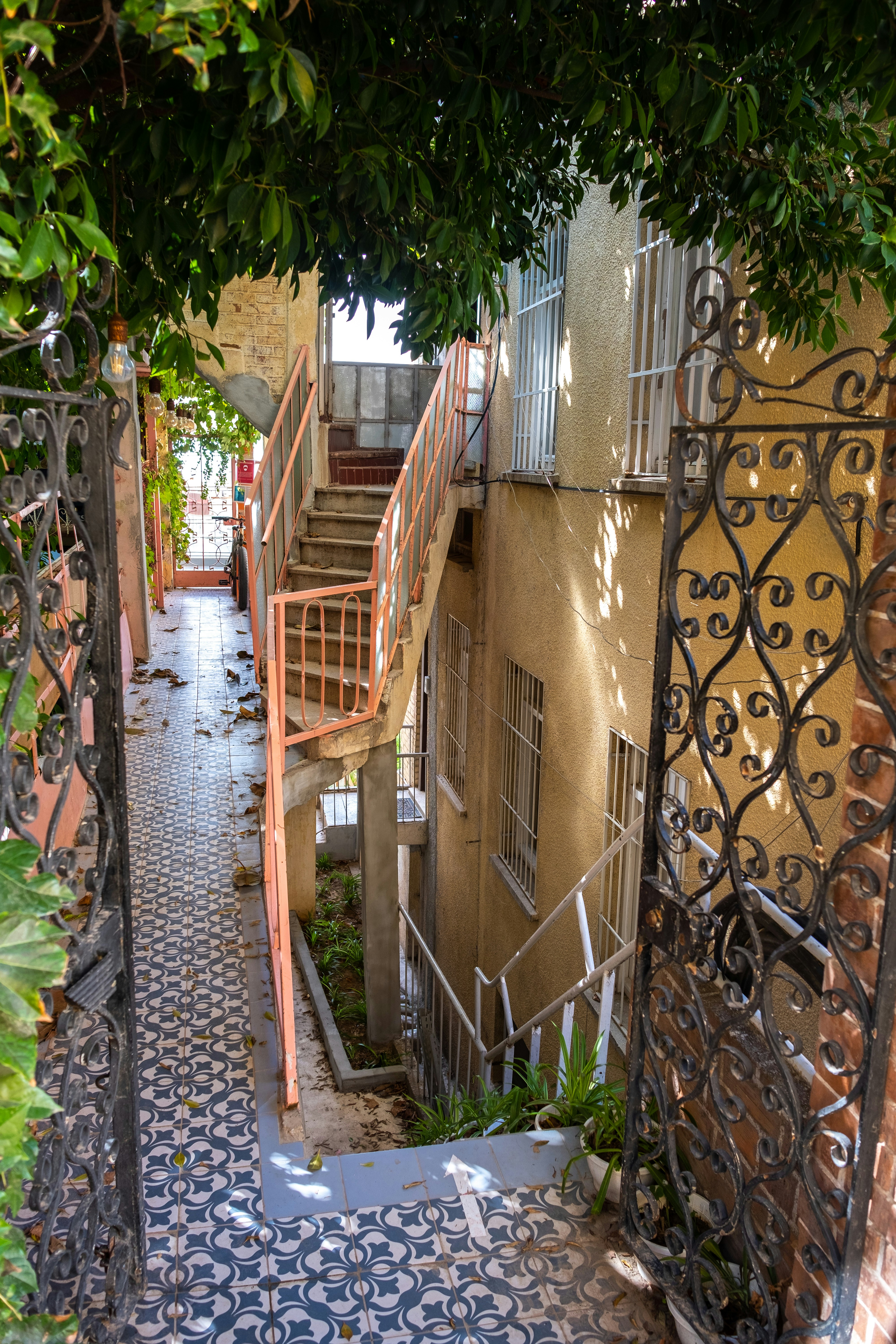 An alleyway with stairs and a tiled floor photo – Free Town Image on ...