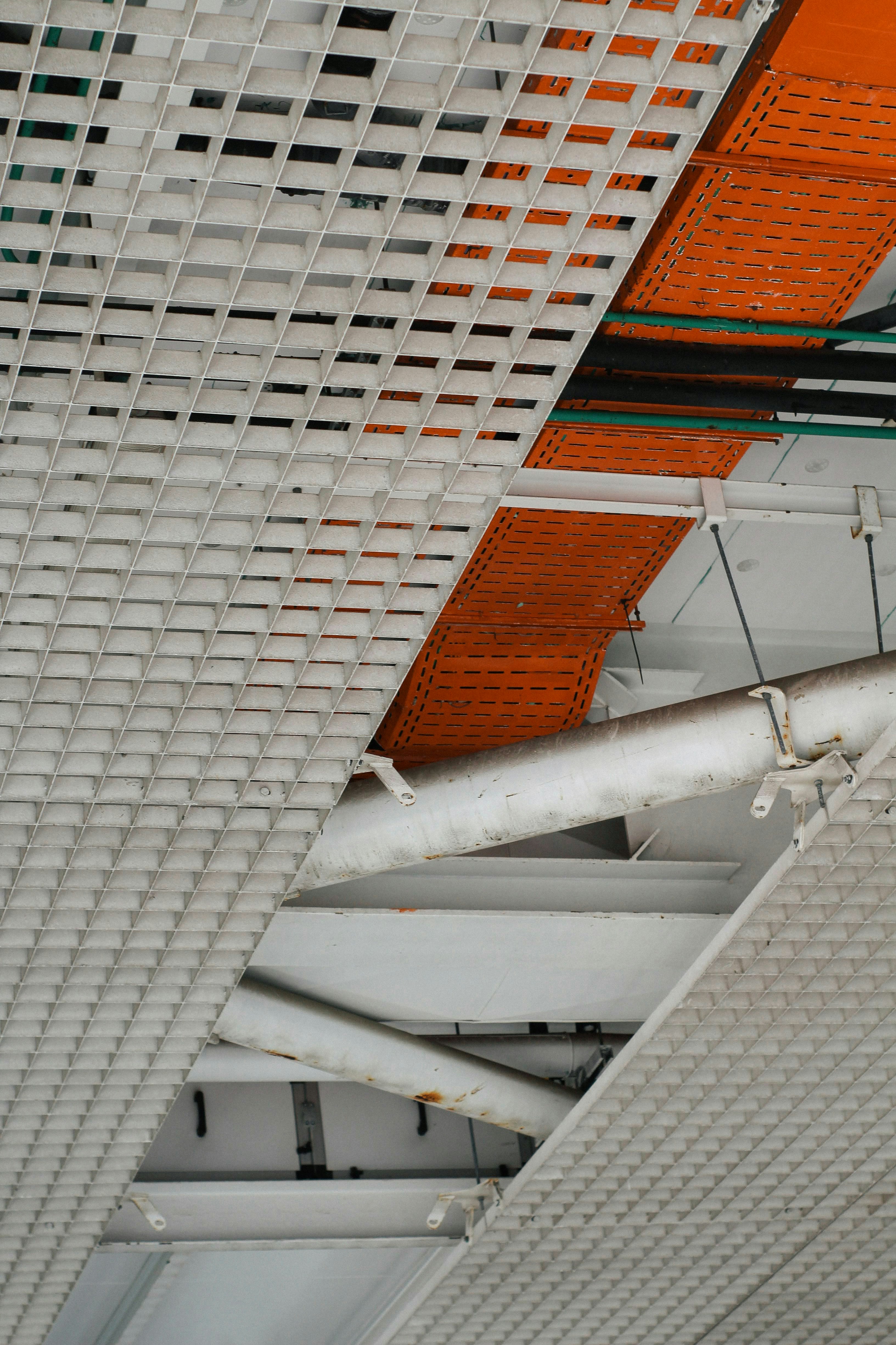 A close up of a metal structure with orange bars photo – Free Design ...