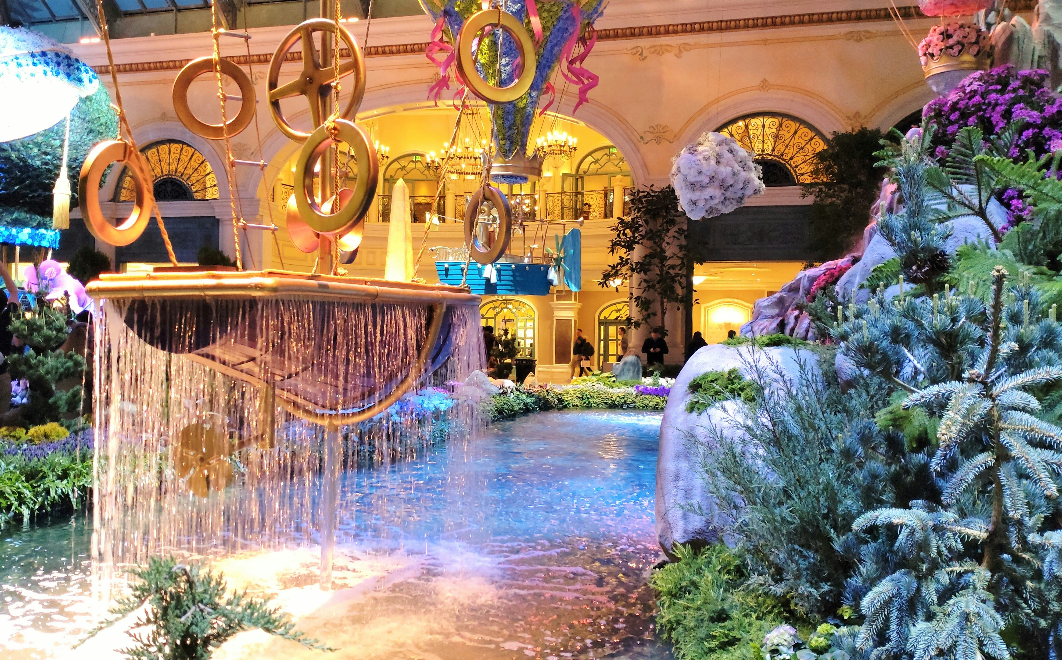 Floating Orbits over a Gilded Atrium Fountain
