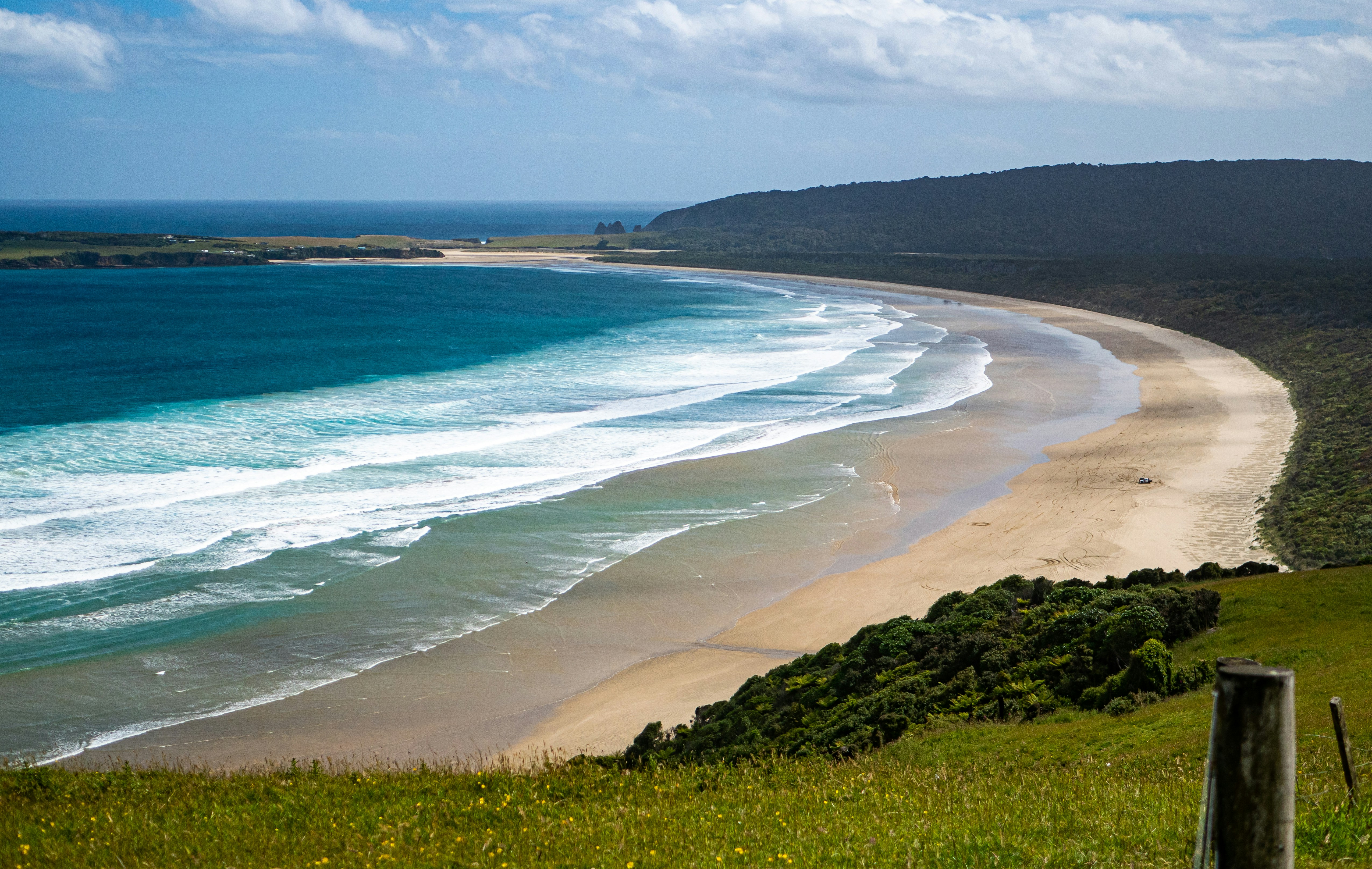 A view of a beach from a hill overlooking the ocean photo – Free ...