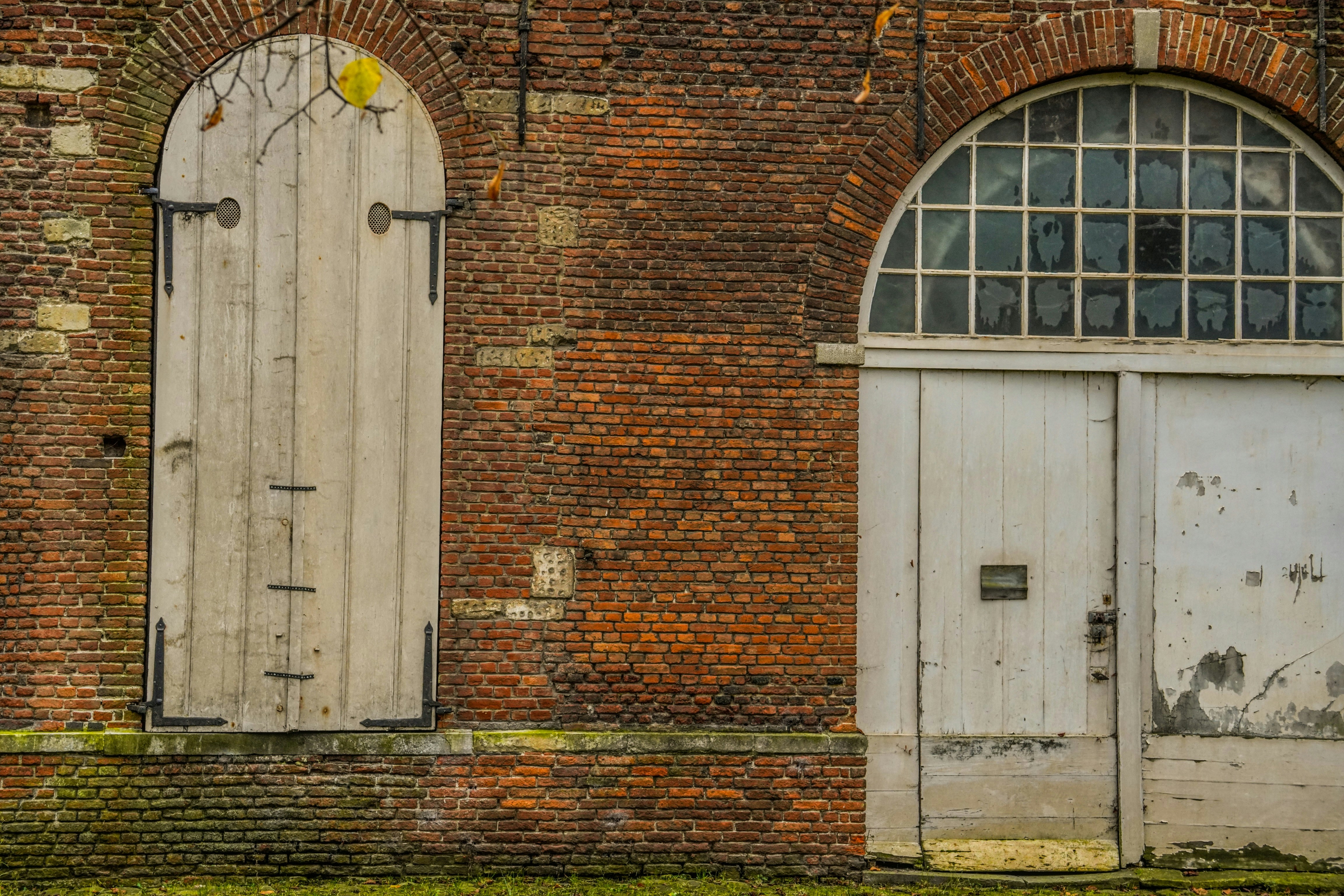 Twin Doors in a Weathered Brick Facade