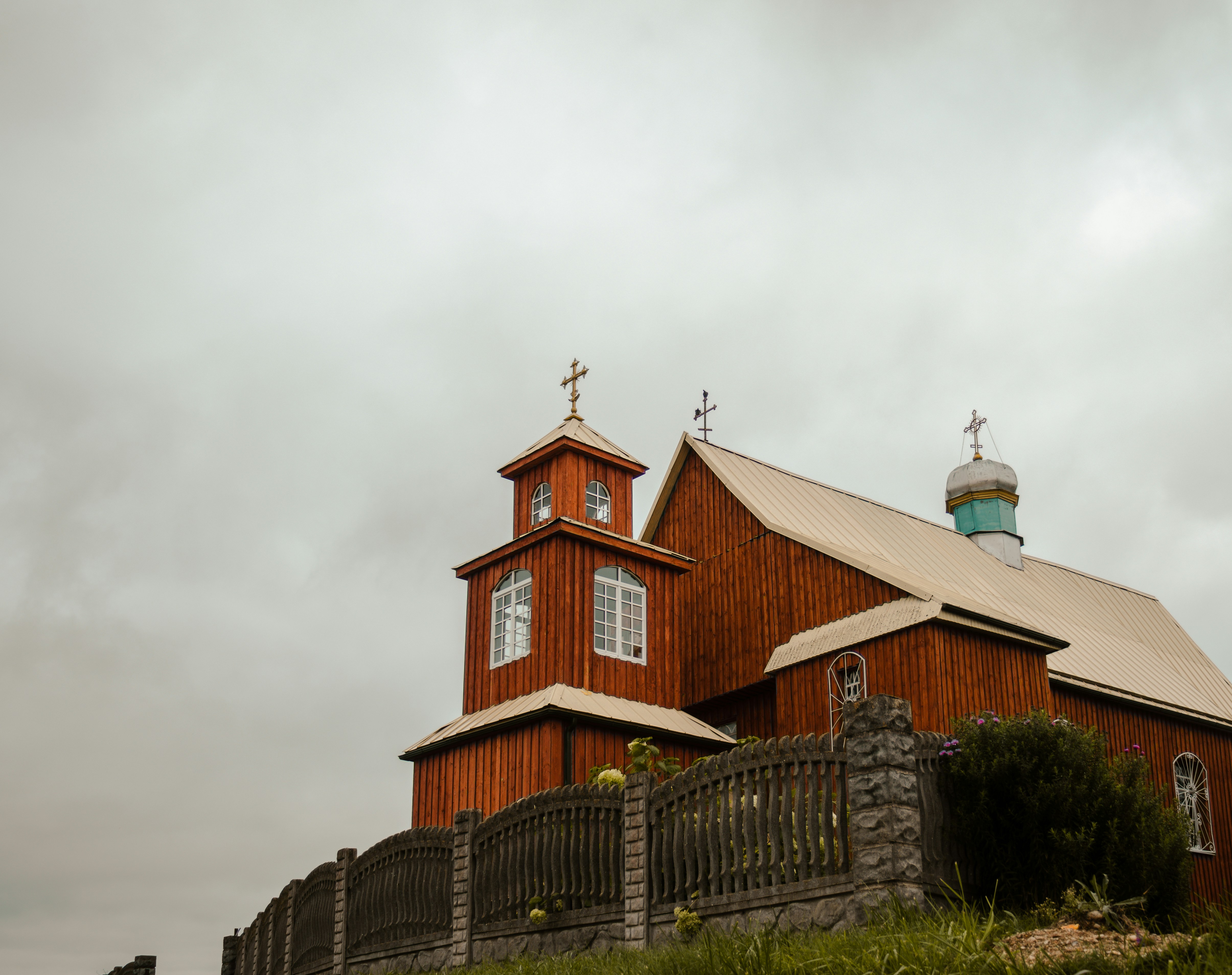 A red church with two steeples on top of it photo – Free Brown Image on ...