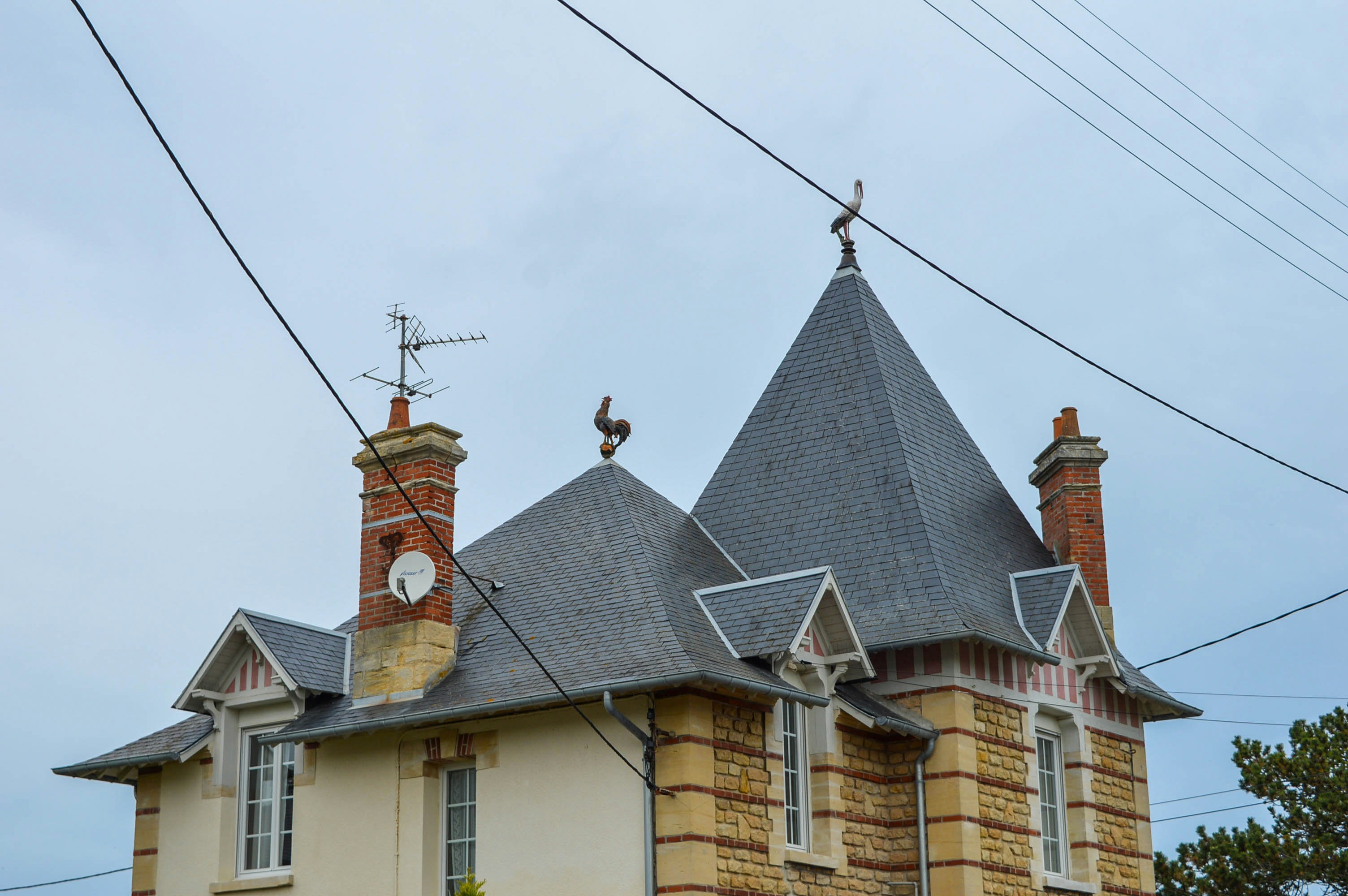 Ridgecrest Weather Vane: a rooster crowns the townhouse roof
