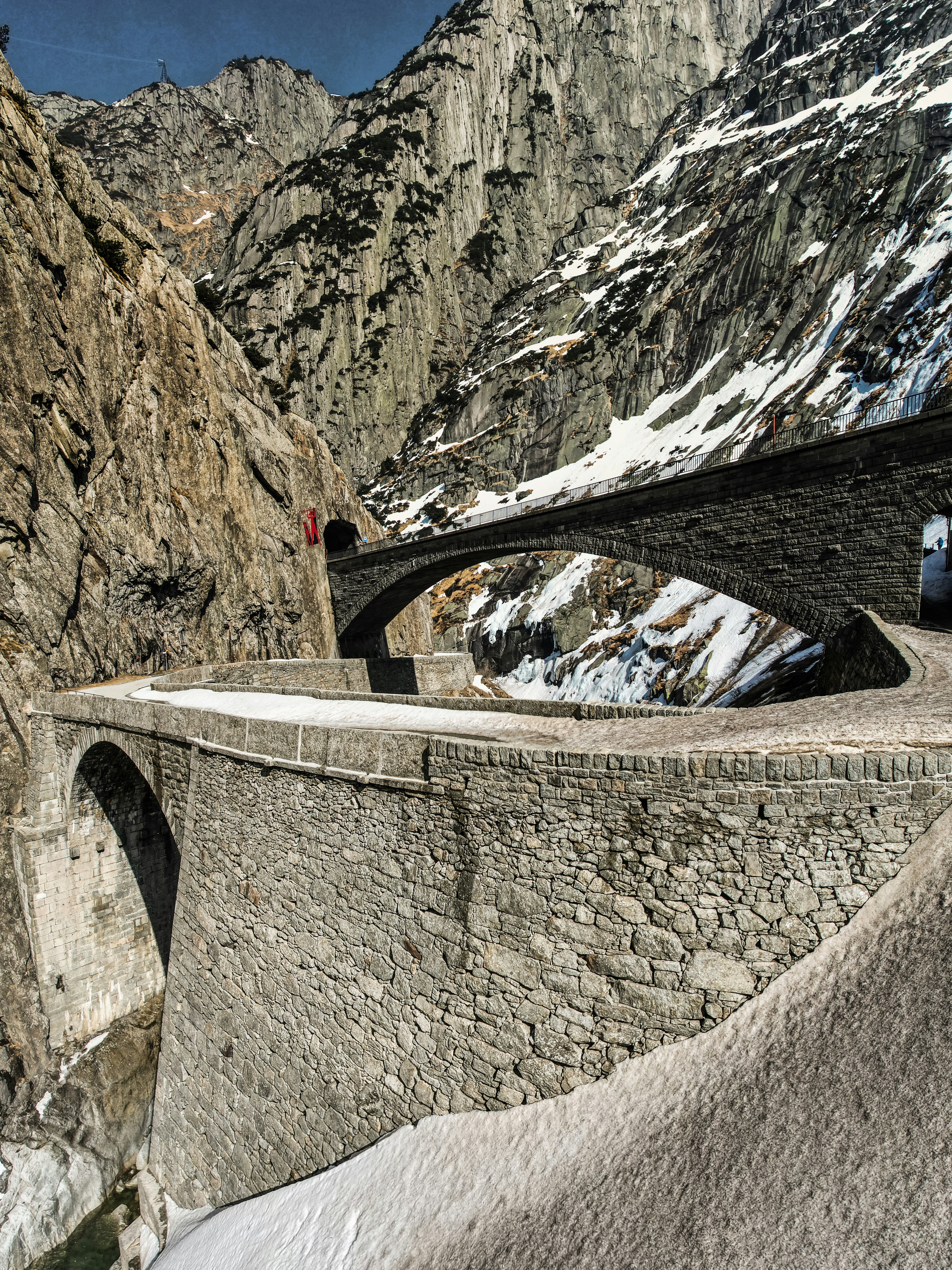A car driving over a bridge in the mountains photo – Free Switzerland ...