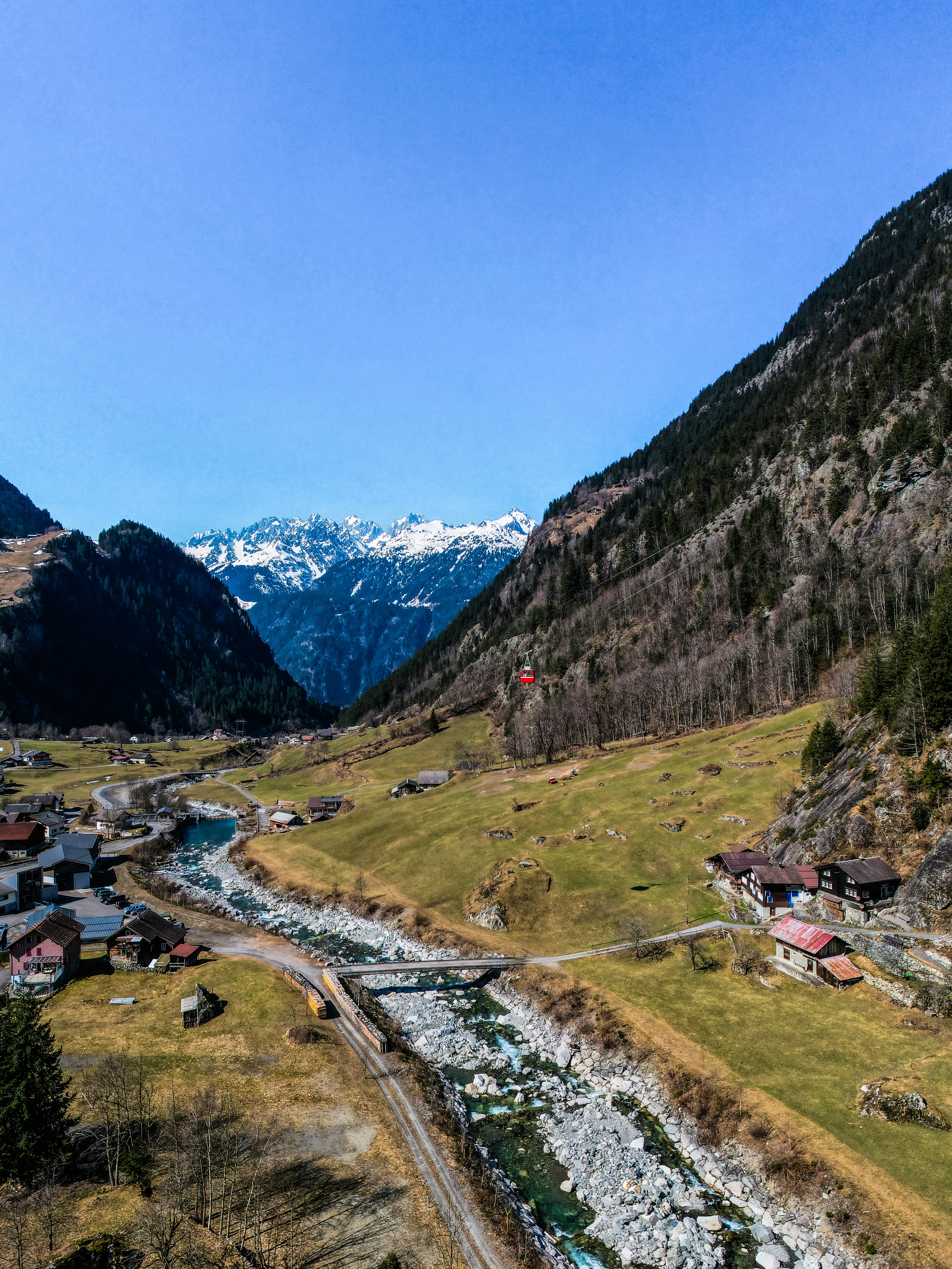 Red Cable Car Skims a Snow-Dusted Alpine Valley