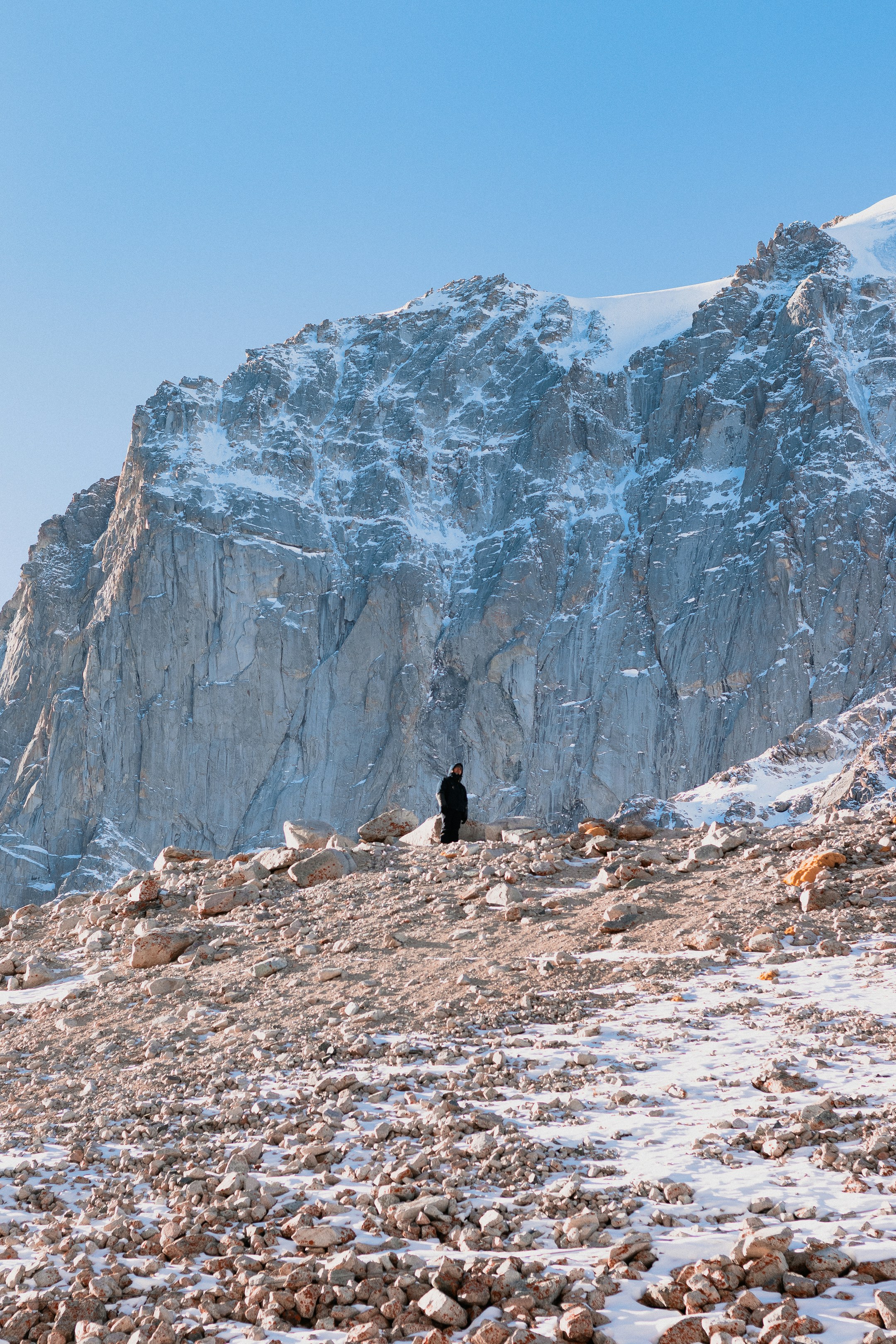 a man standing on top of a snow covered mountain
