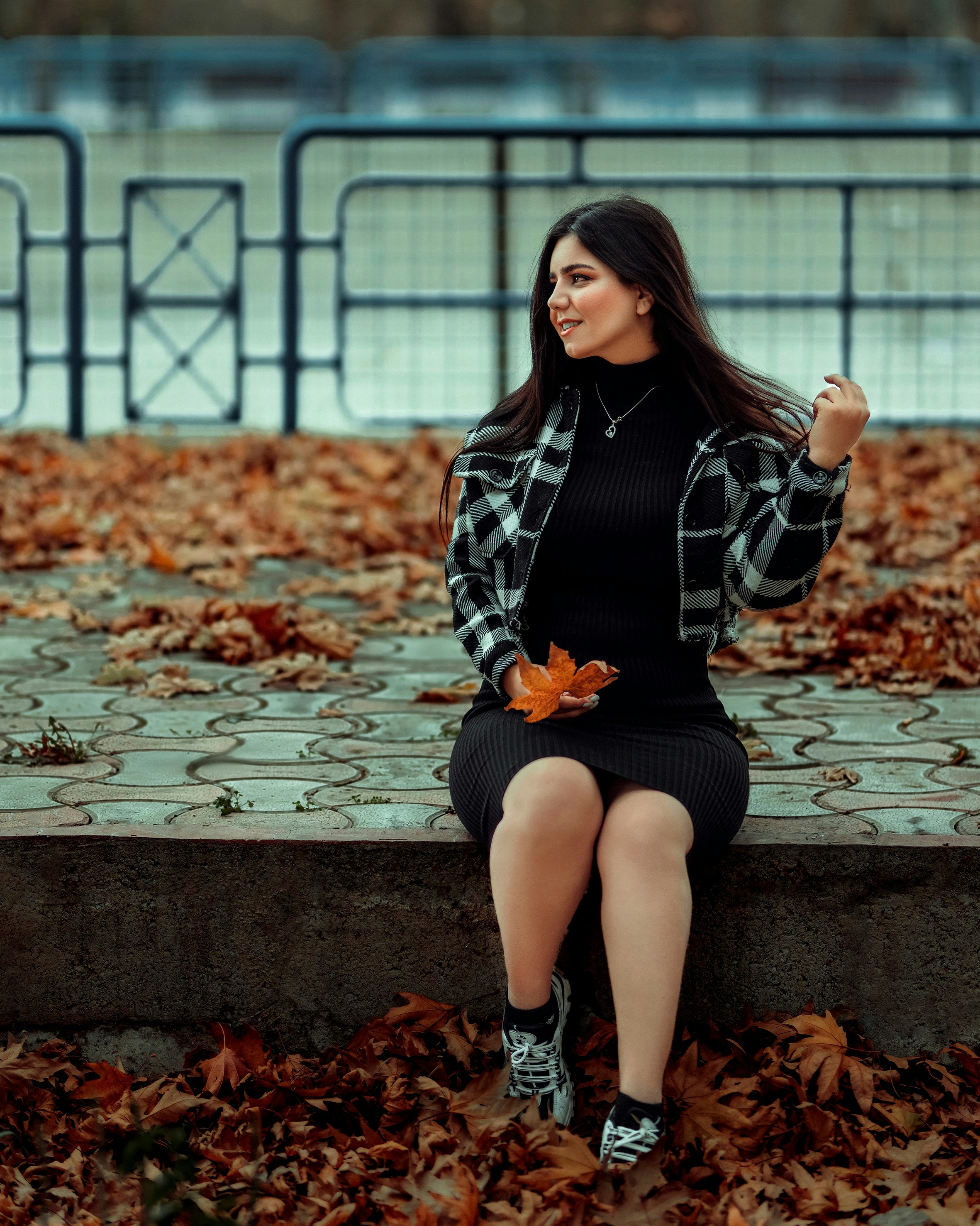 A woman is sitting on a bench in the leaves photo – Free Iraq Image on ...