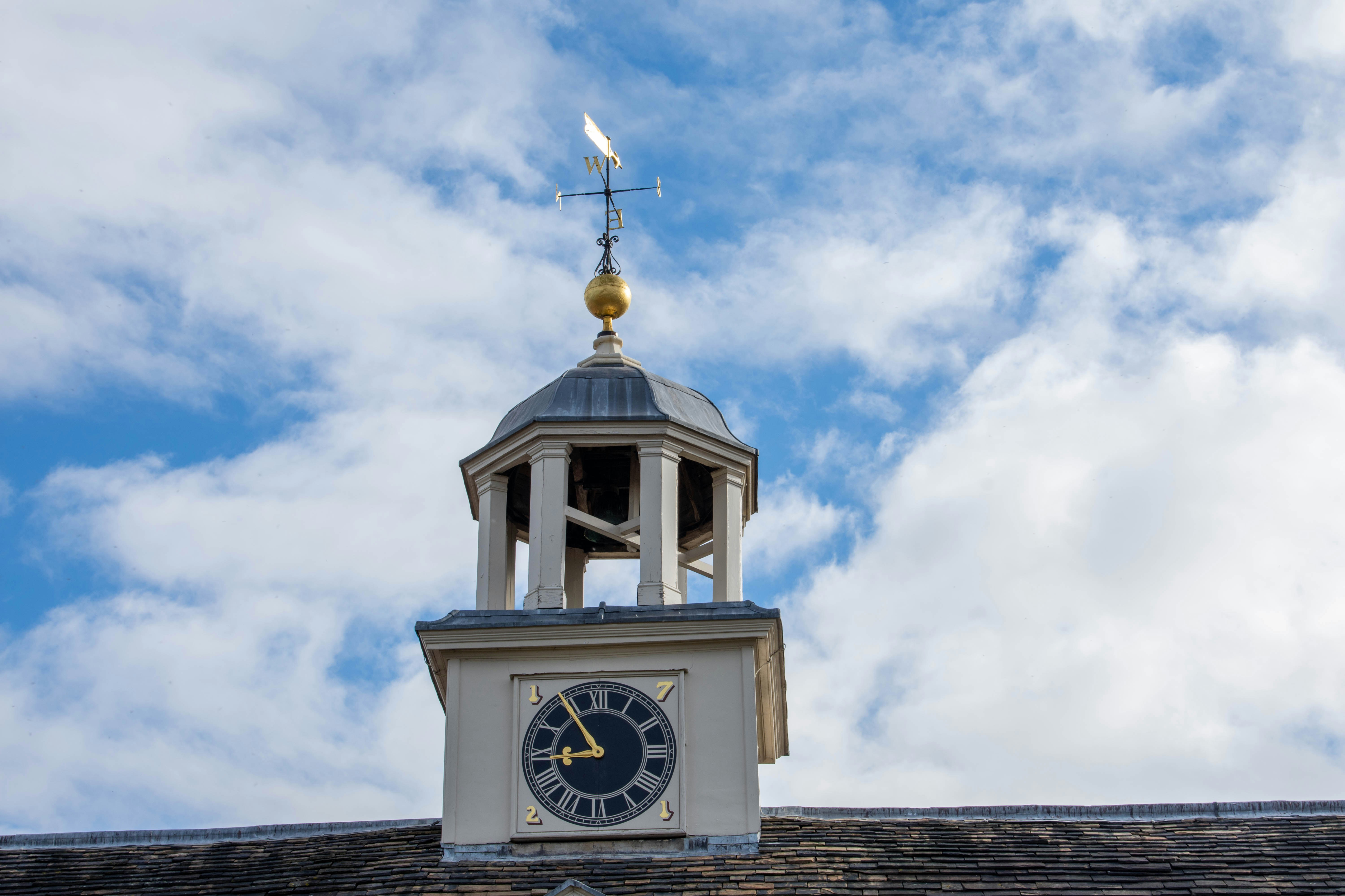 Clock Tower Crest: A Weathered Weathervane Touching the Sky