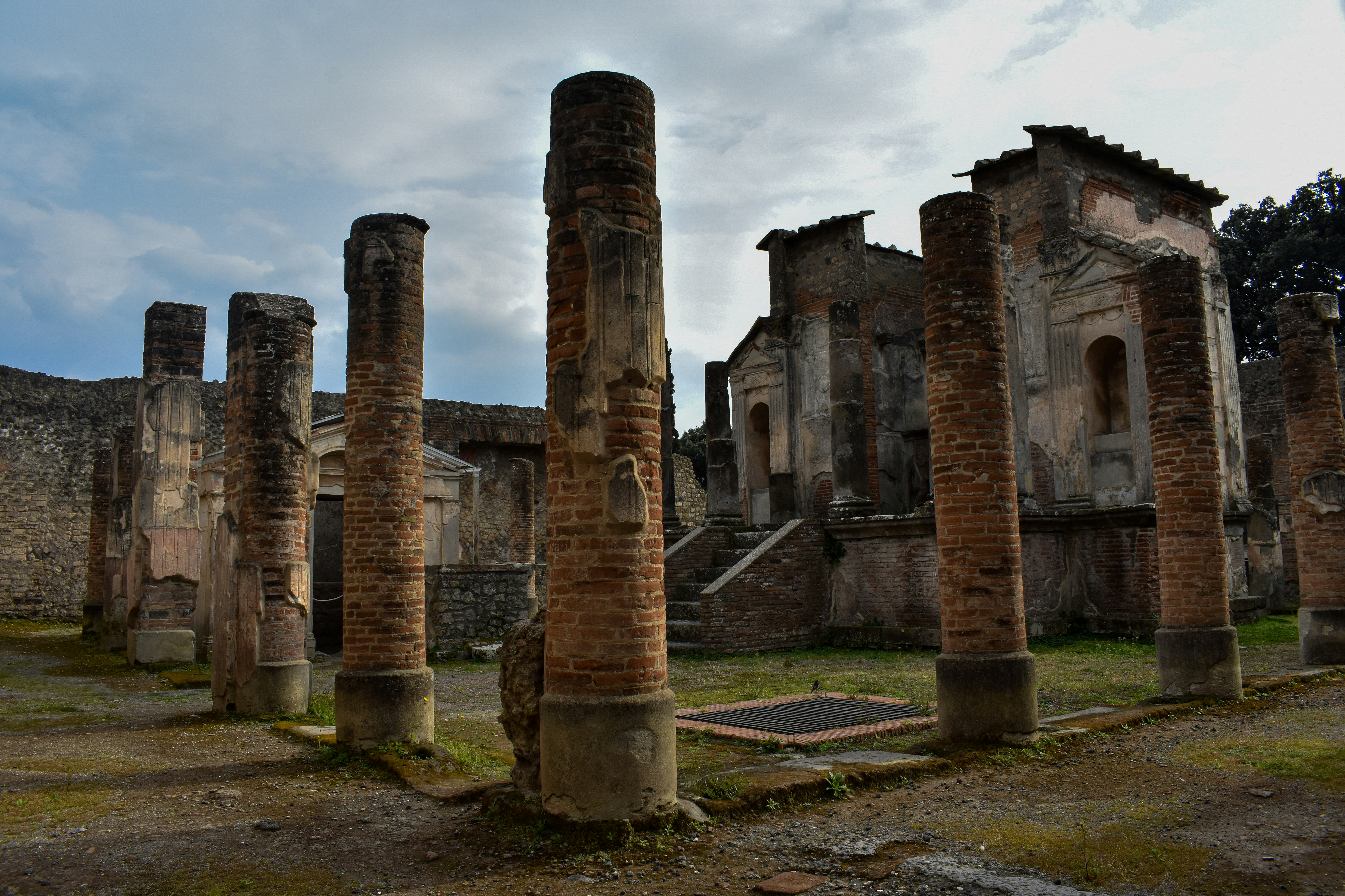 Ancient brick columns stand guard over the ruins of Pompeii, revealing glimpses of a once-thriving civilization. The remnants of structures hint at the stories long lost to time.