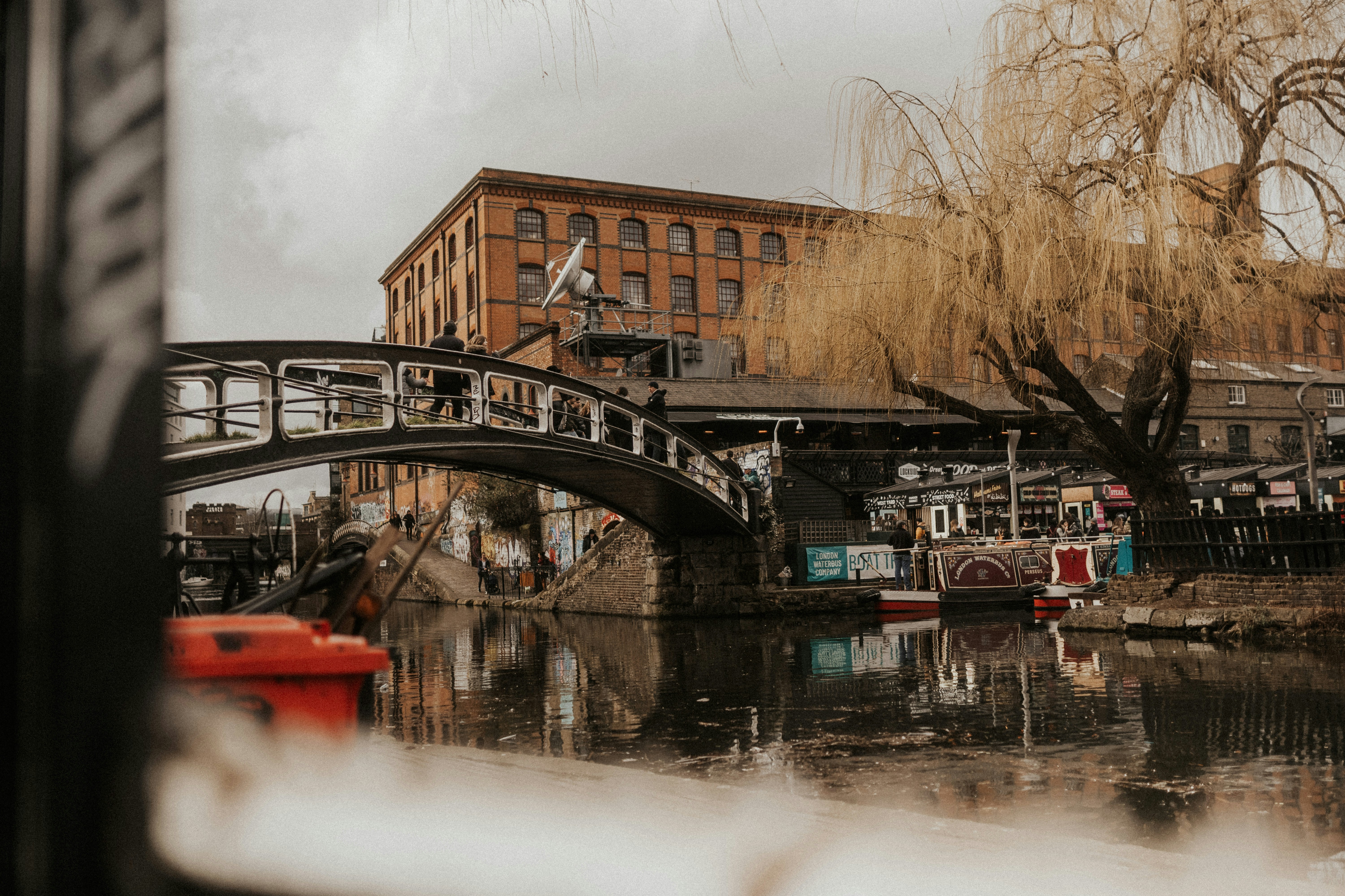 A bridge over a body of water with a building in the background photo ...