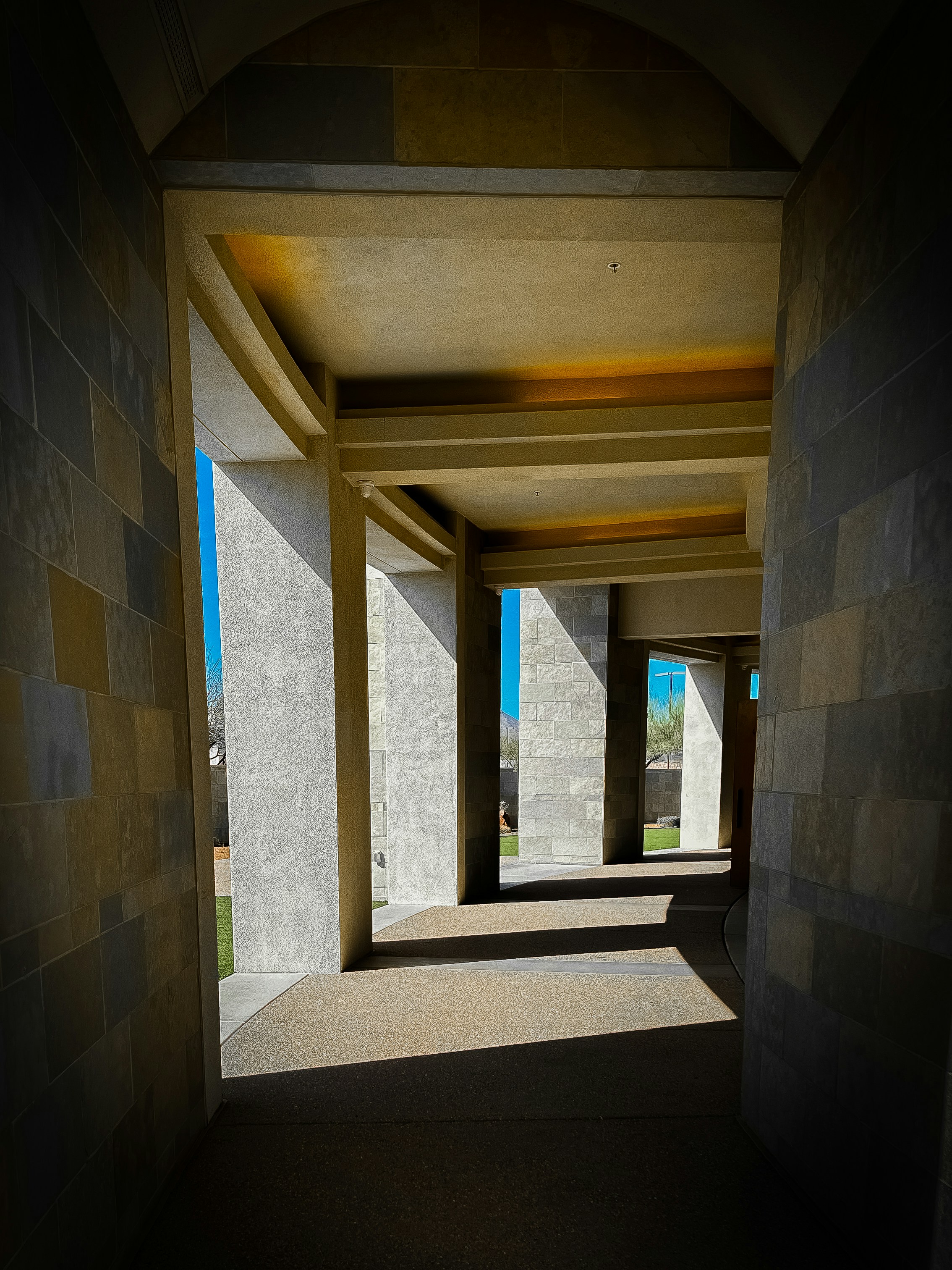 Vanishing Lines: Sunlit Arches in a Concrete Arcade