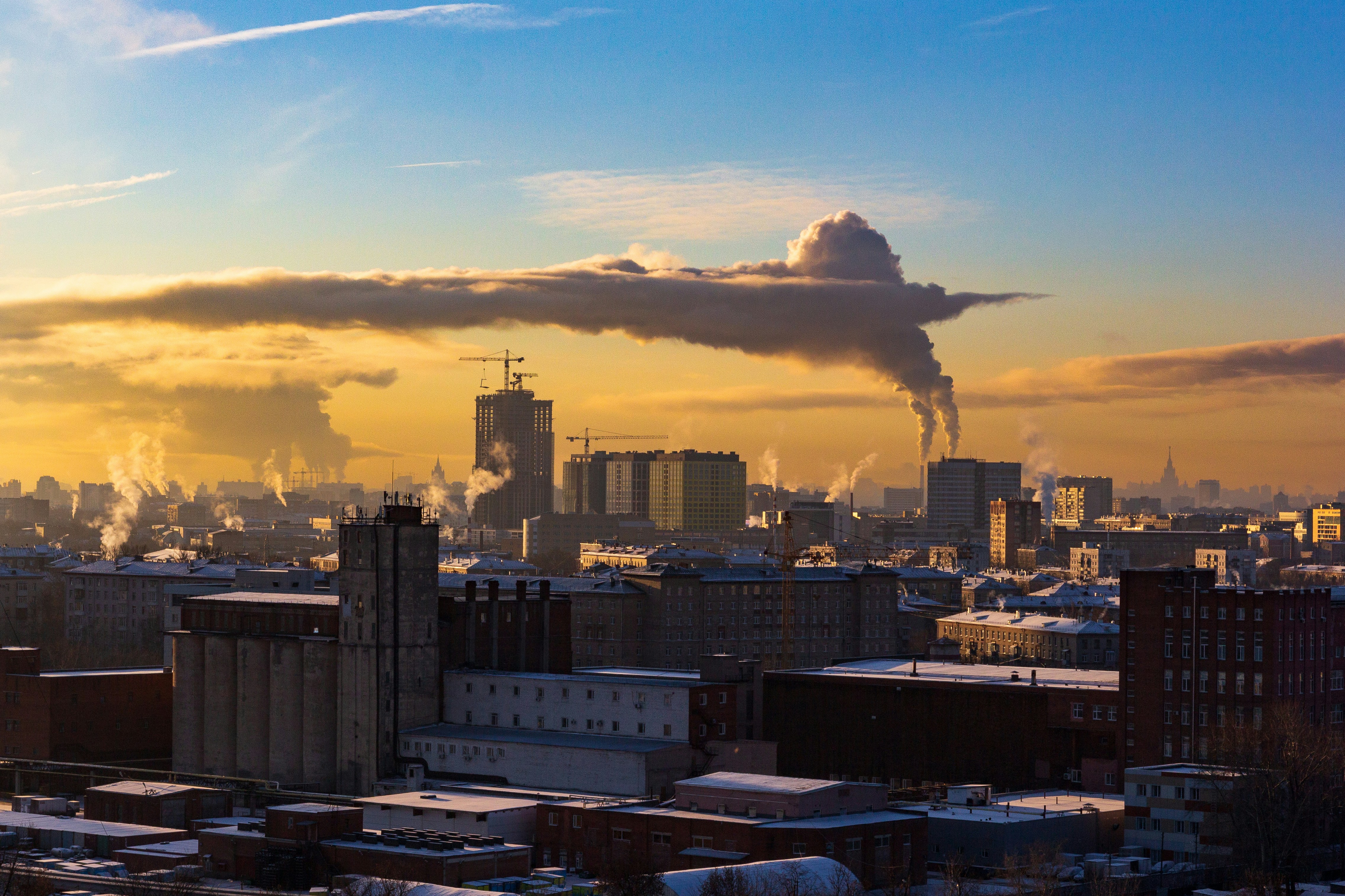 Sunset Steam over a Frosted City: An Industrial Silhouette at Dusk