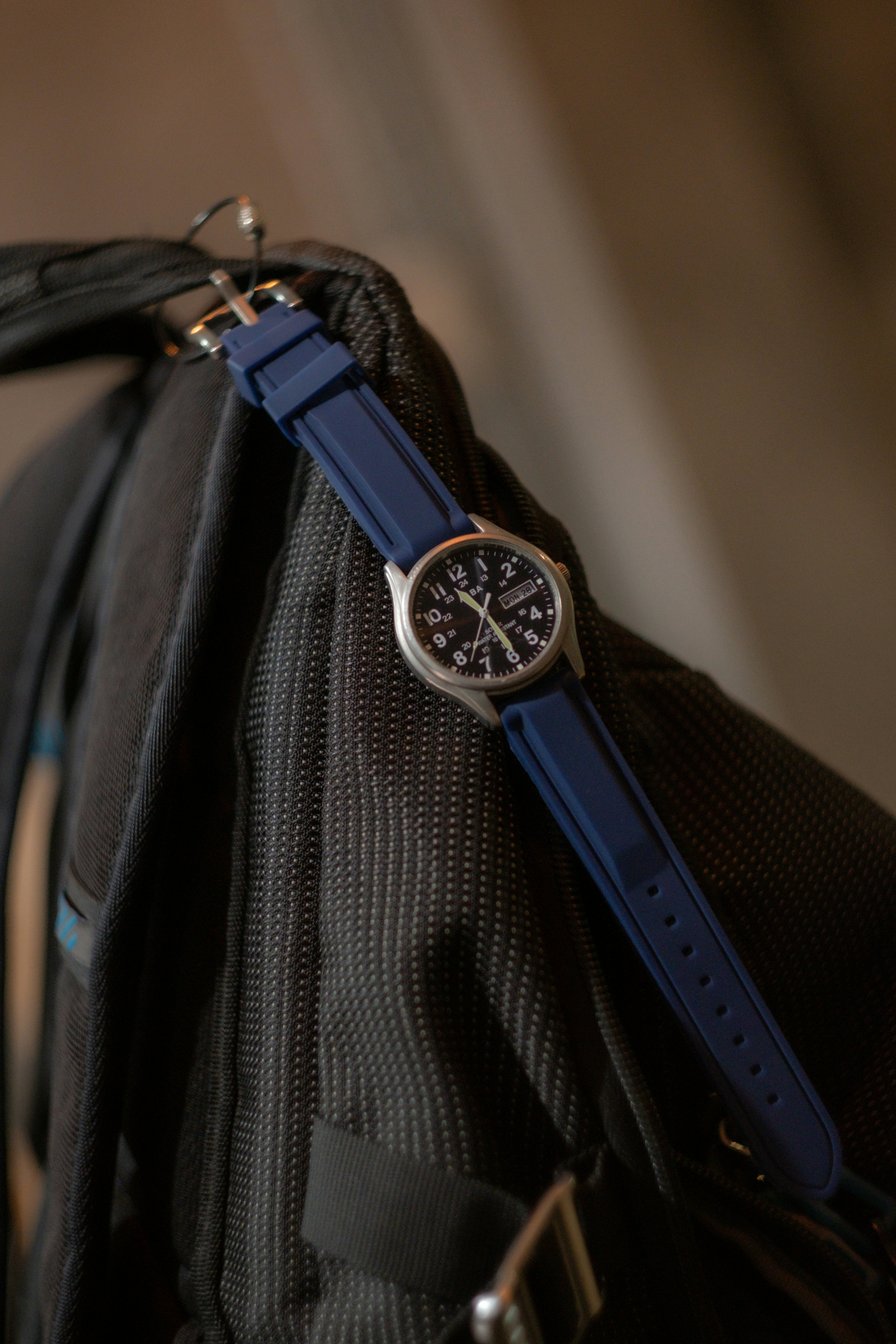 Timekeeper tethered to a rugged backpack strap