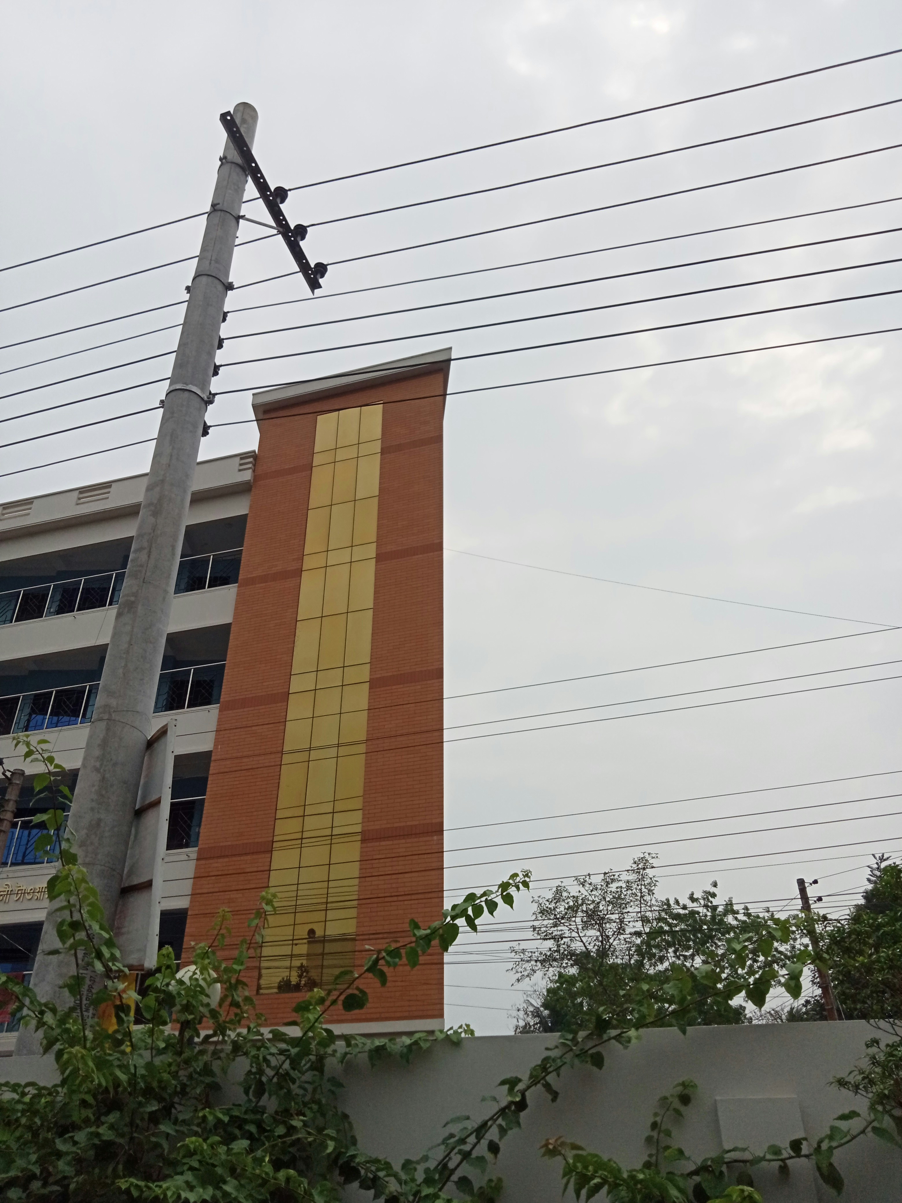 Towered Perspective: Urban Streetlight and Brick Facade under Cable Lines