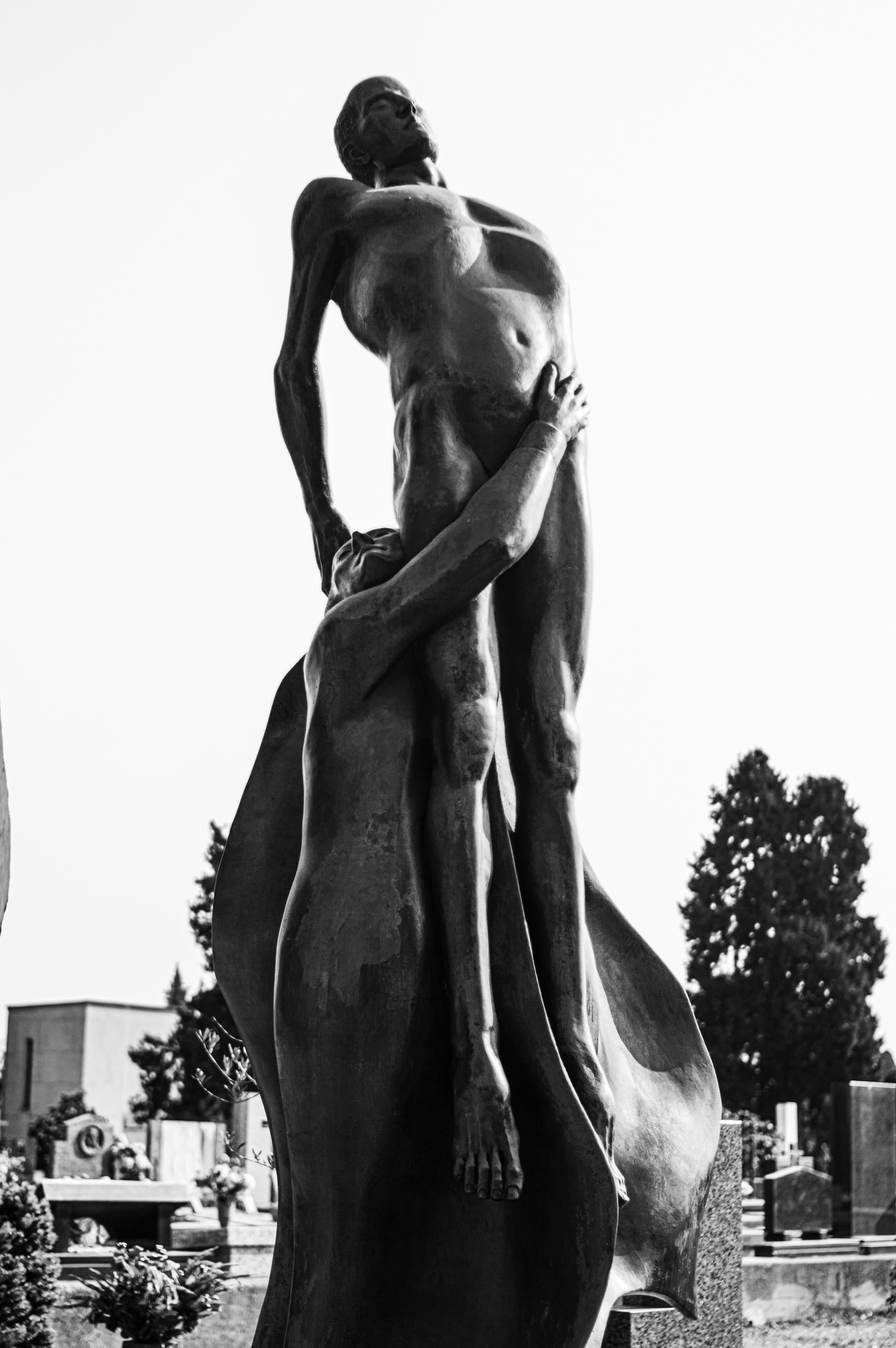Monolithic Embrace: A Dual-Form Sculpture in a Cemetery