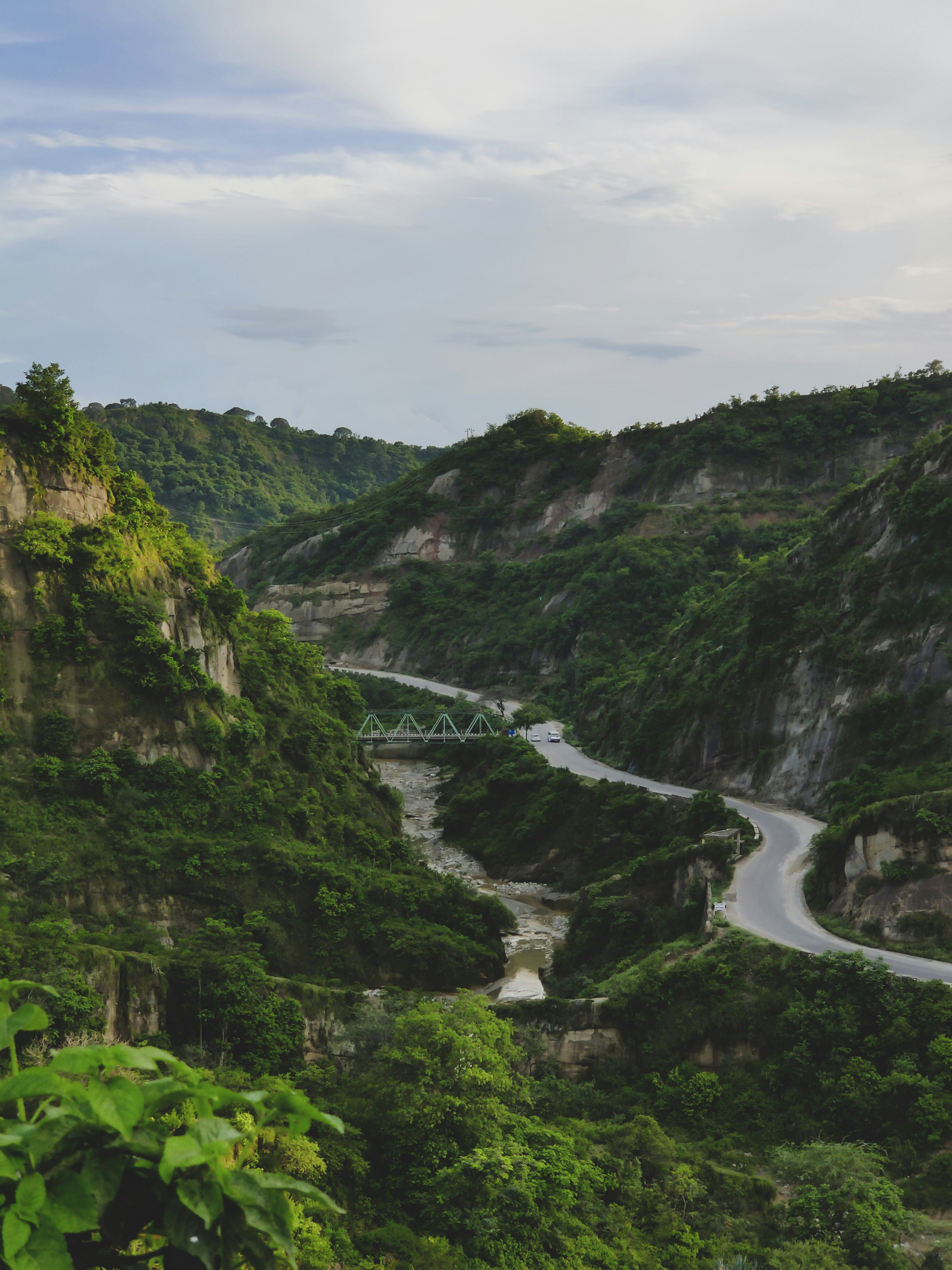 Serpentine Road Through Verdant Cliffs