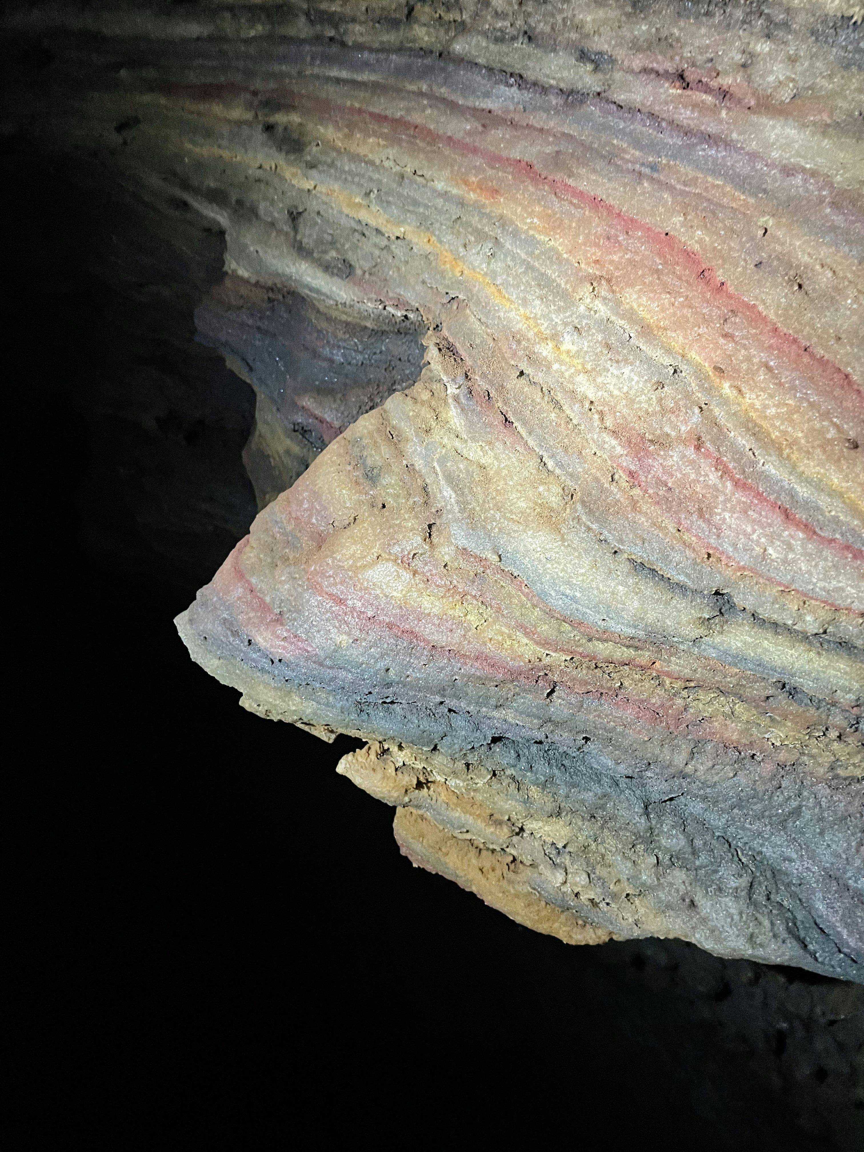 Whispers of the Earth: Colorful Strata in Darkness