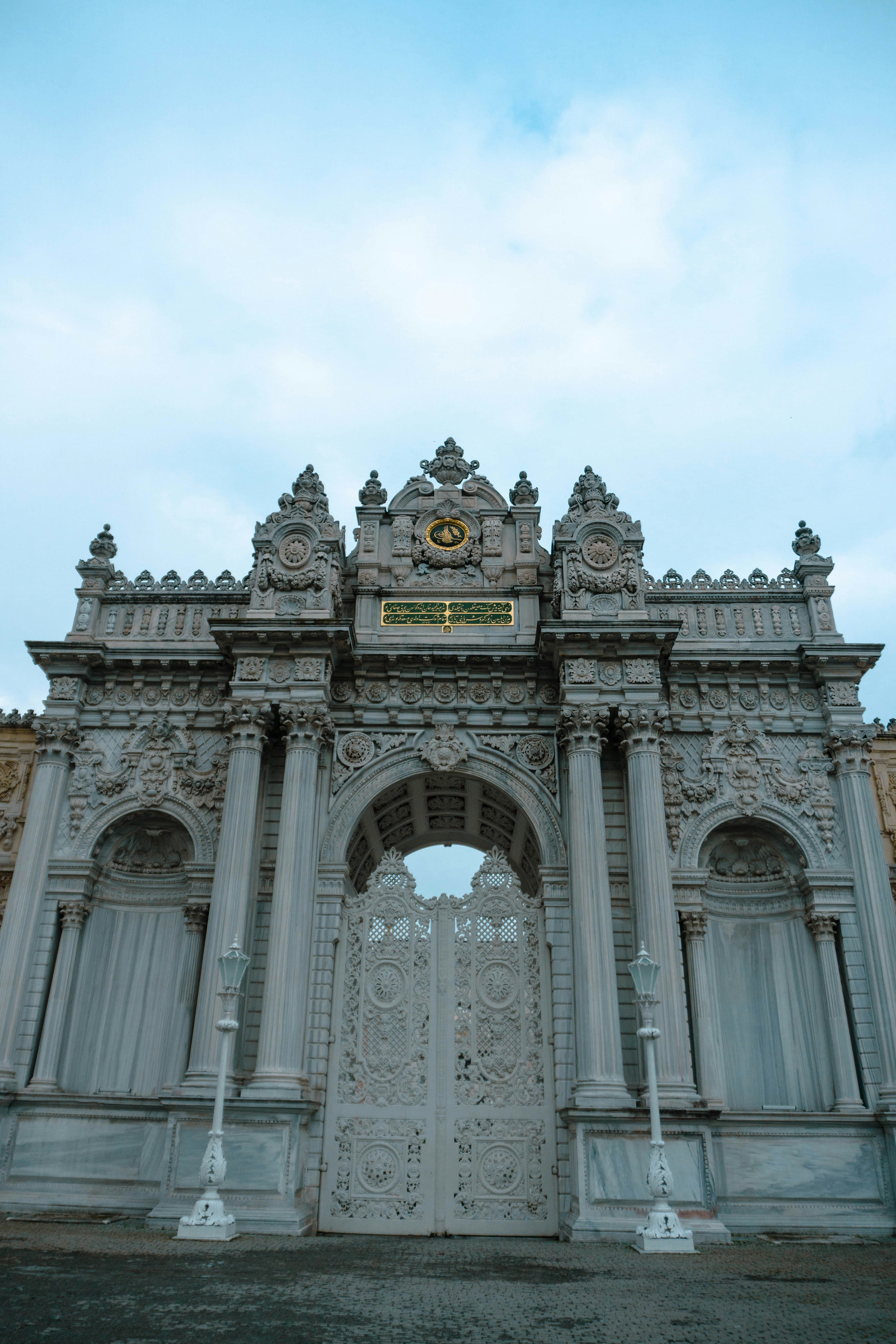 Monolithic Marble Gate: Intricate Carvings Stand Against a Pale Sky
