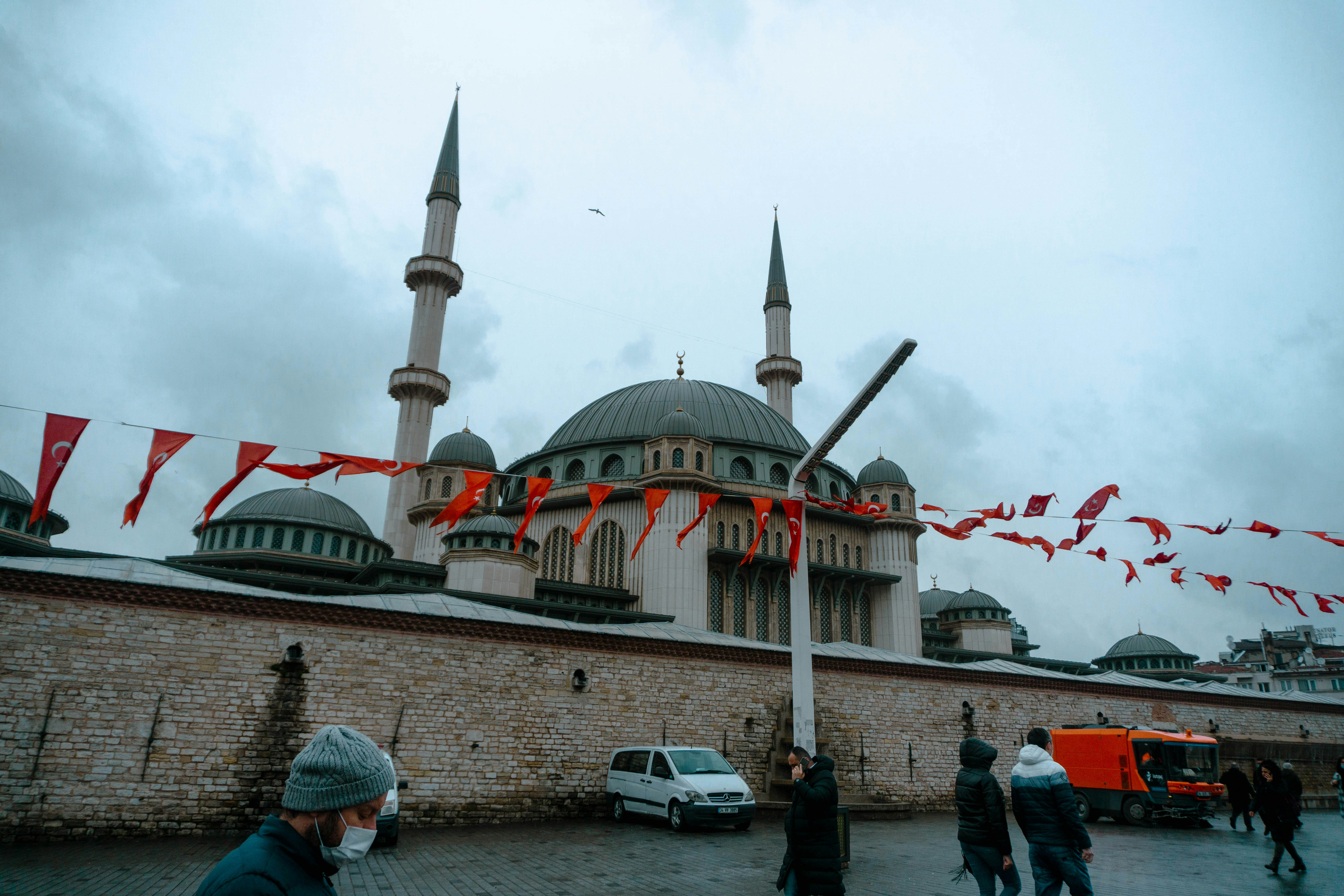 Red Flags, Stone Walls, and a Mosque in the Evening Light
