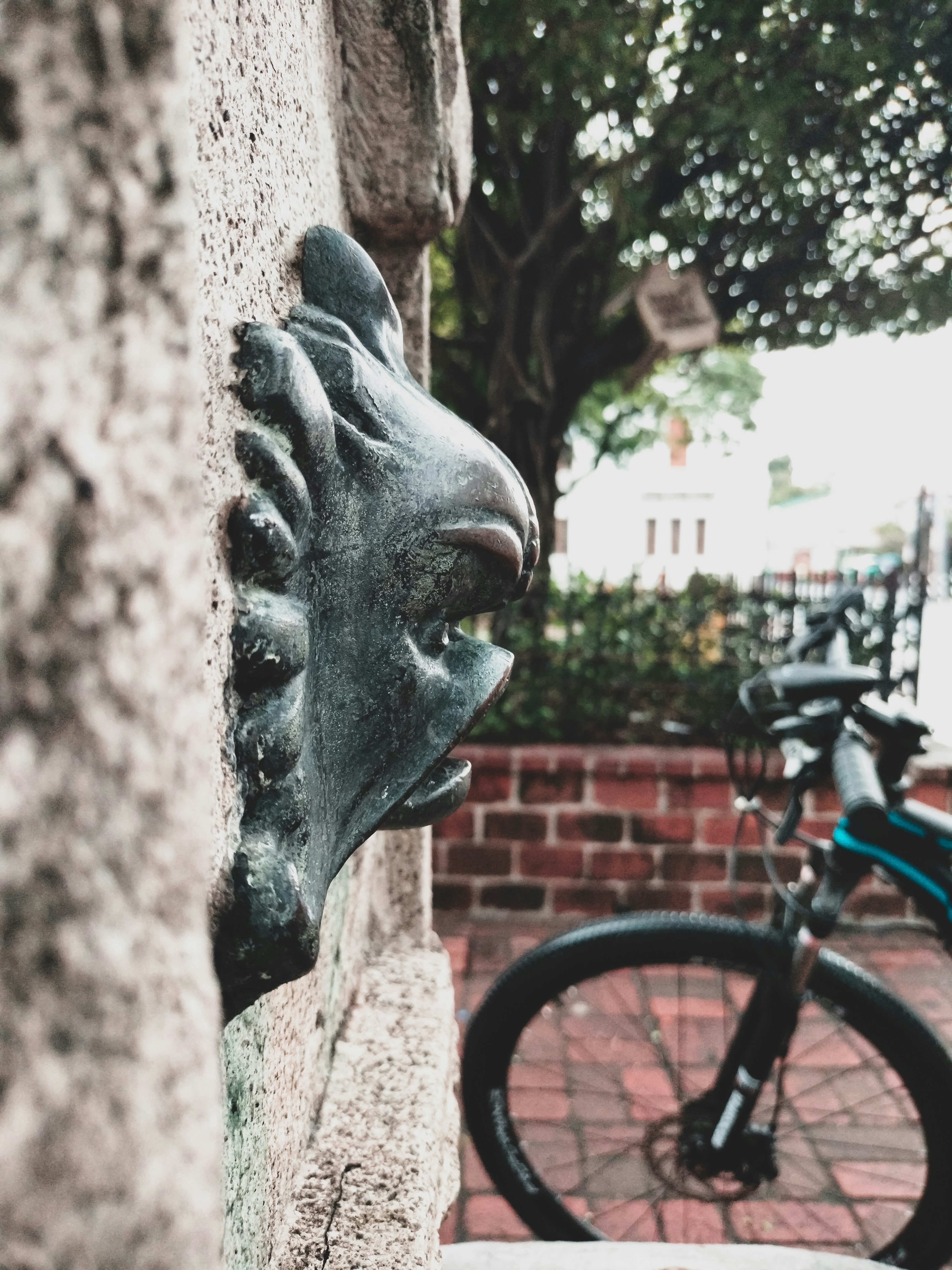 A bike parked next to a stone wall photo – Free Grey Image on Unsplash