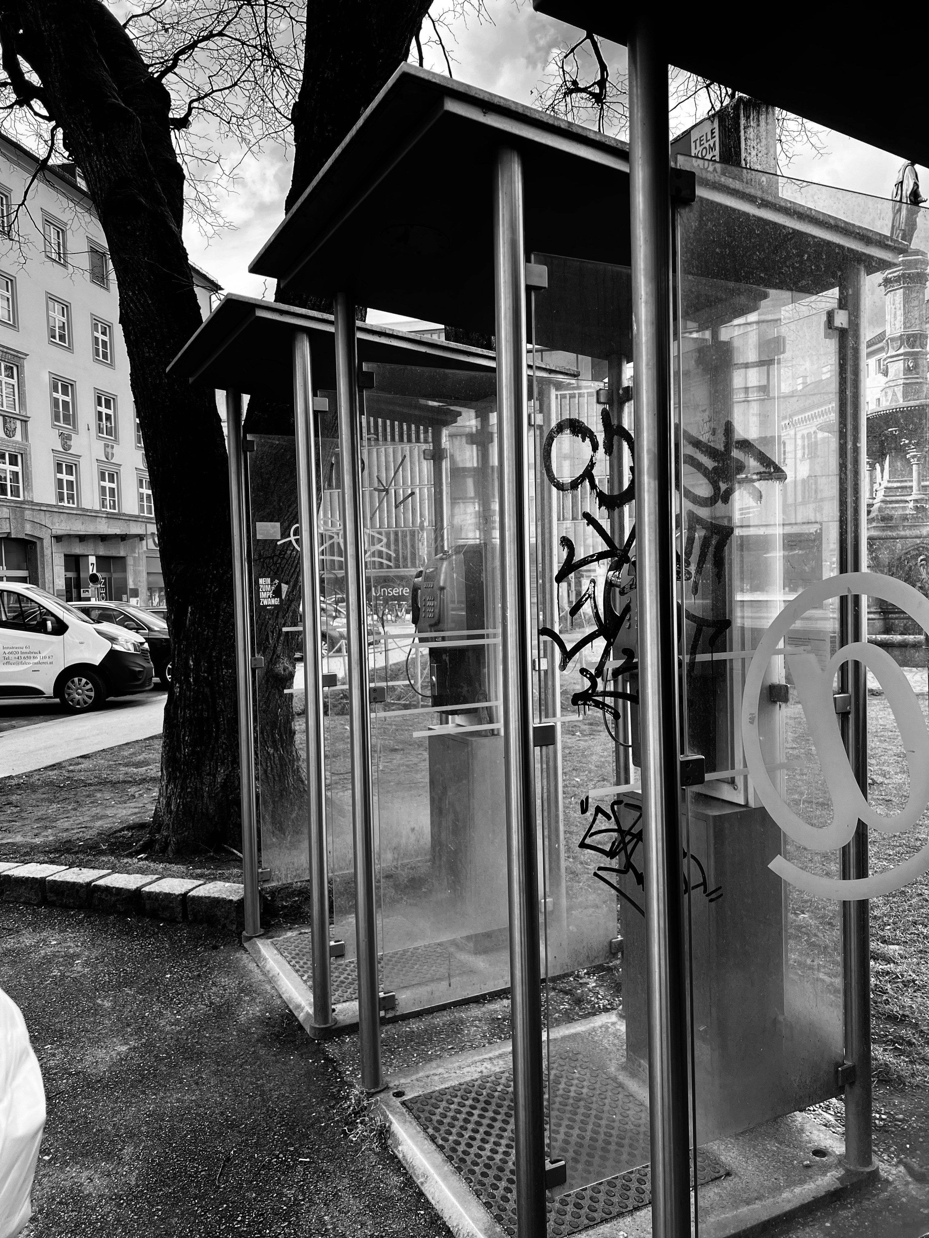 Monochrome Graffiti Glass: Urban Bus Shelter in Focus
