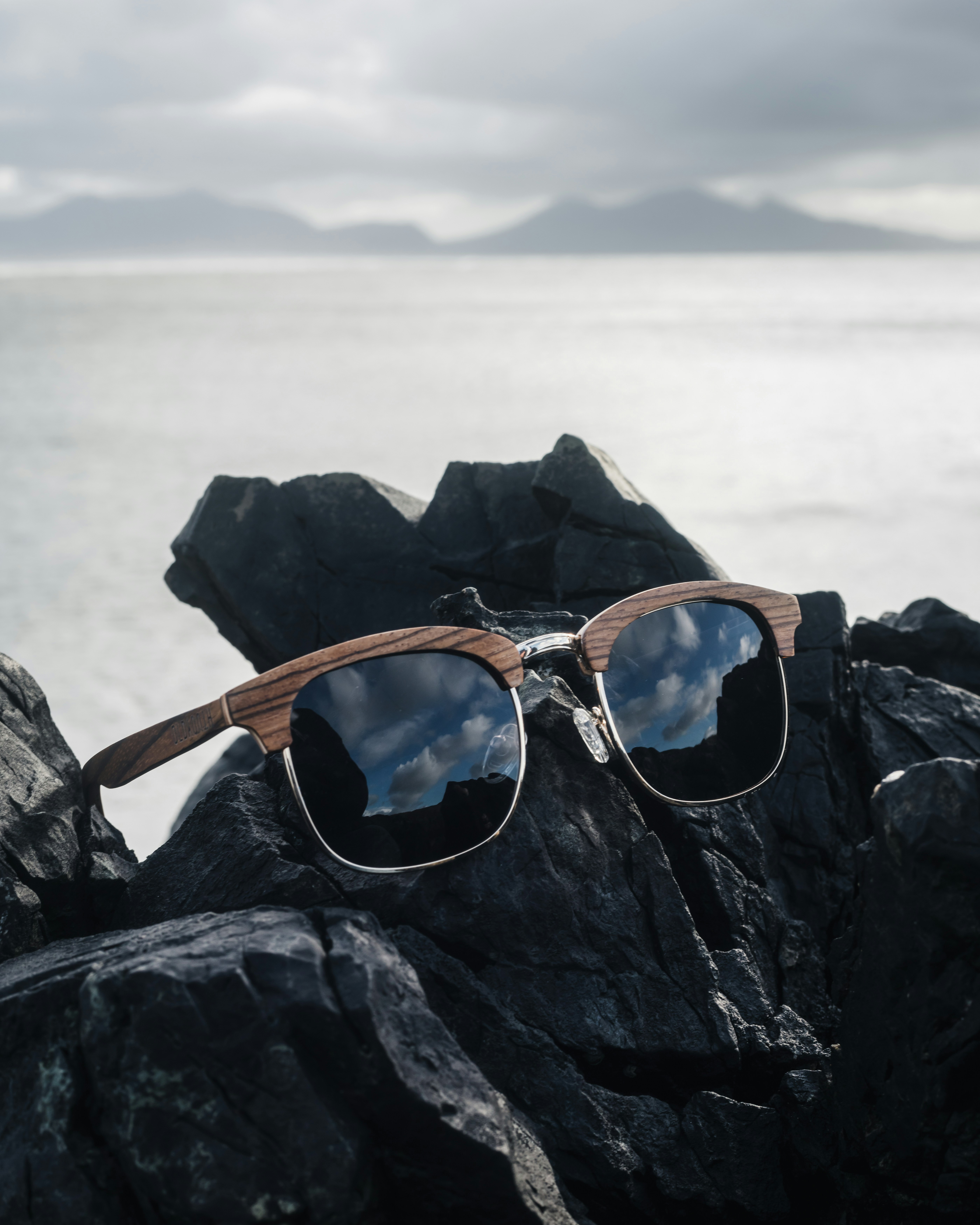 Sky Reflections in Wooden Frames Resting on Sea-worn Rocks