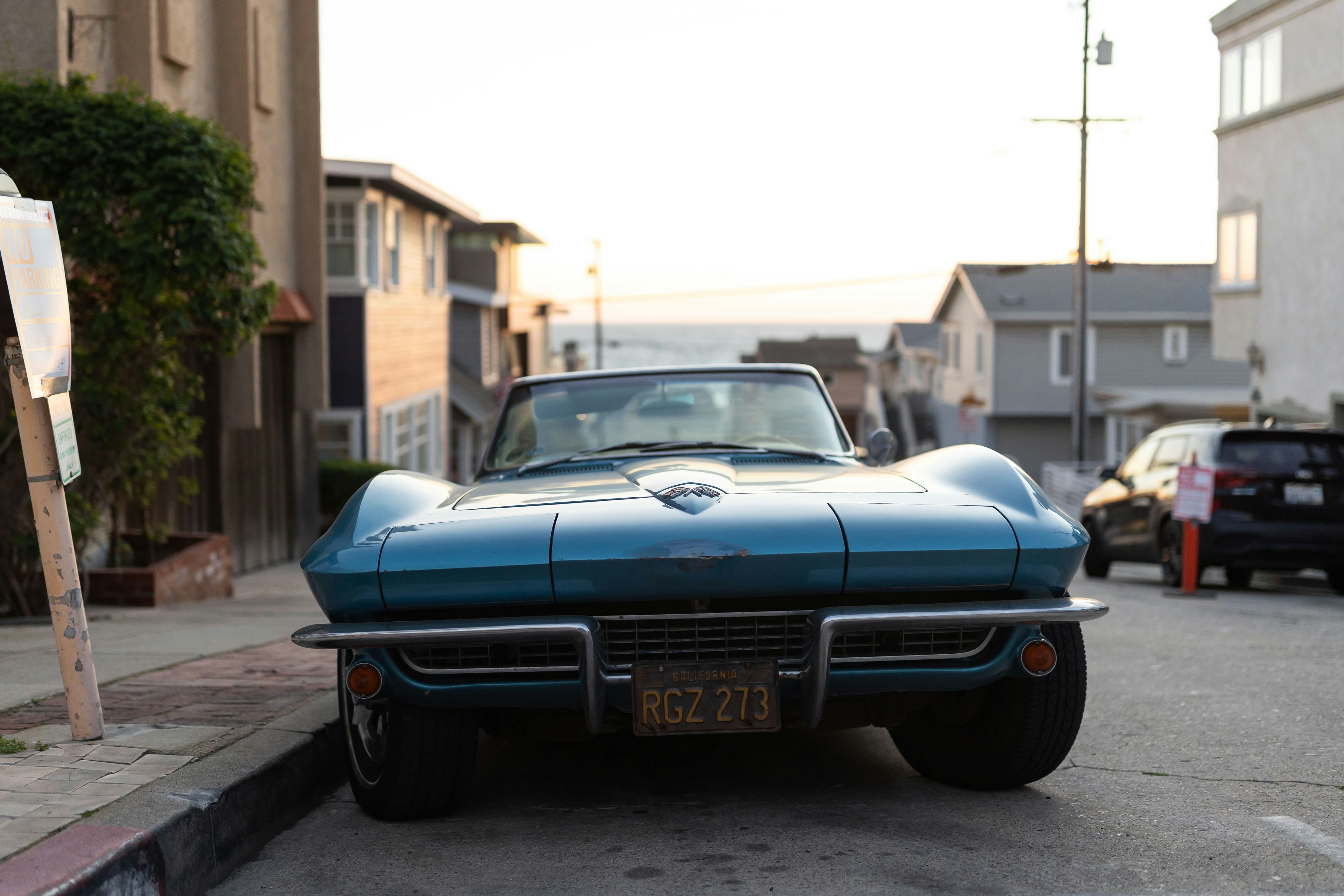 A blue car parked on the side of the road photo – Free Chevy Image on ...