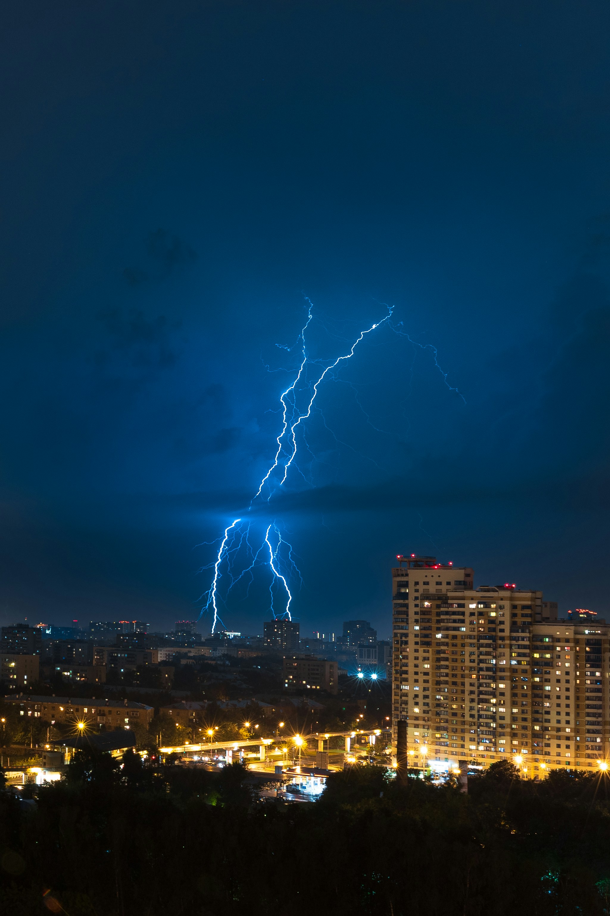 A lightning bolt strikes over a city at night photo – Free Moscow Image ...