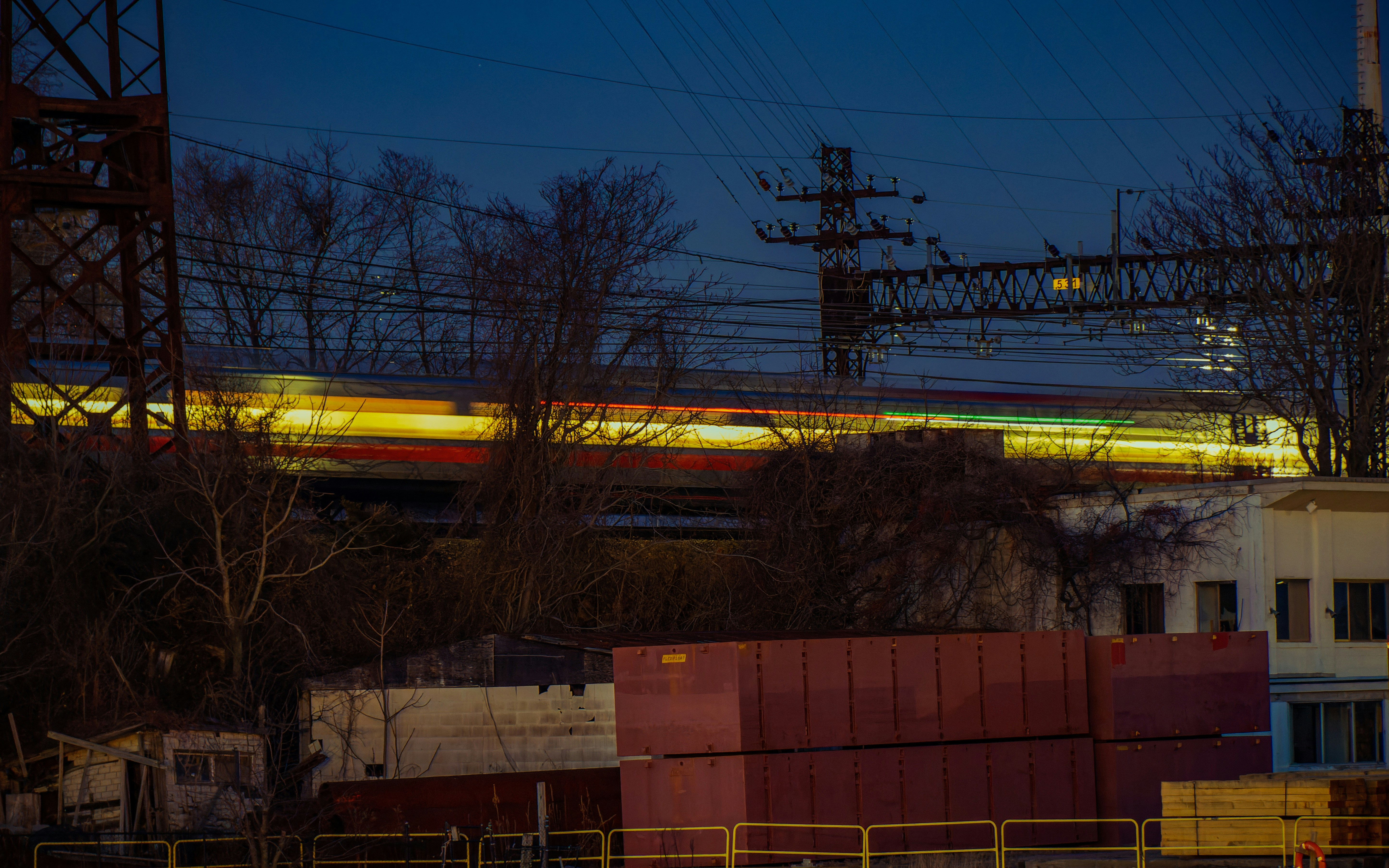 Night Train Light Trail Over a Quiet Freight Yard