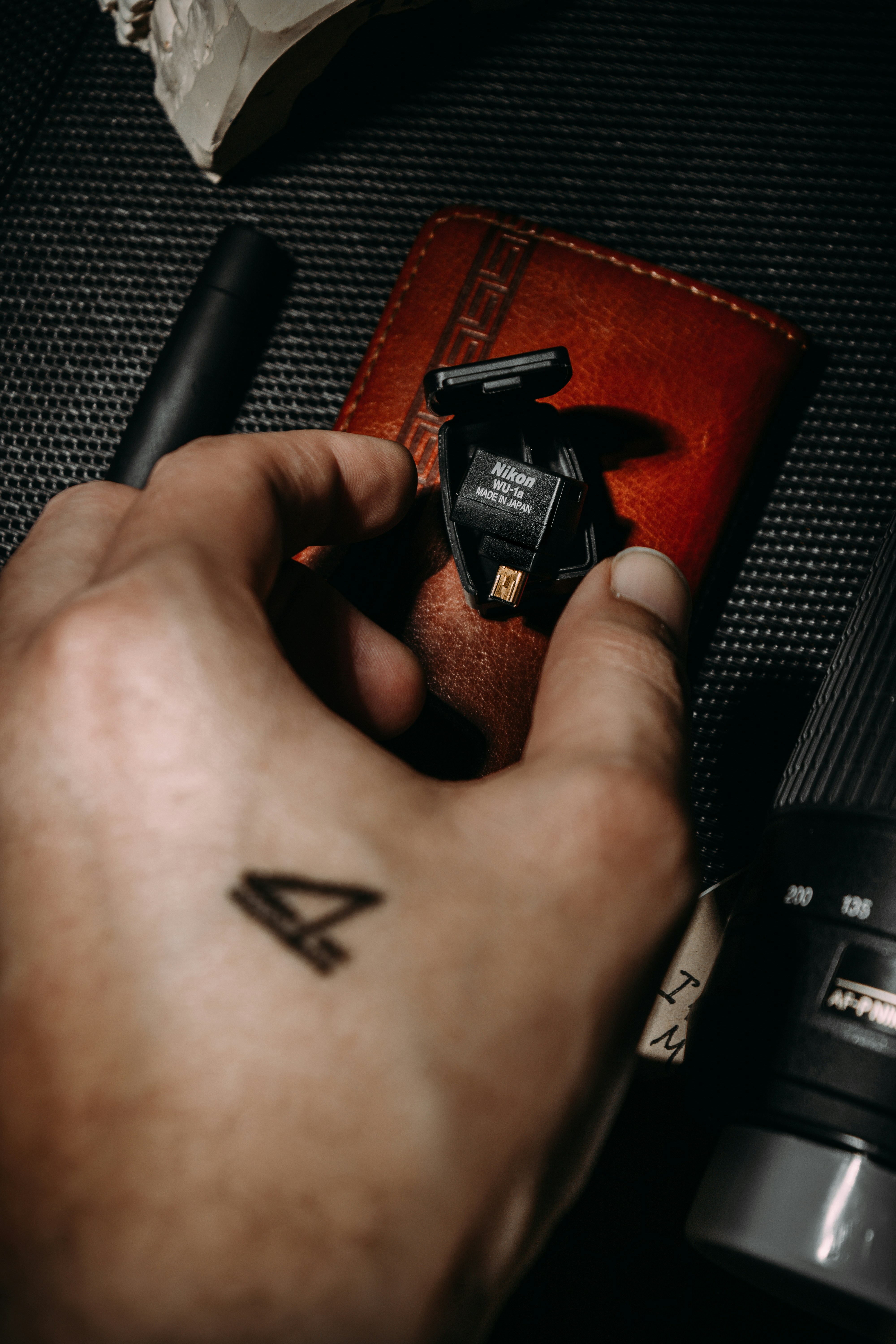 a person with a tattoo on their left hand
