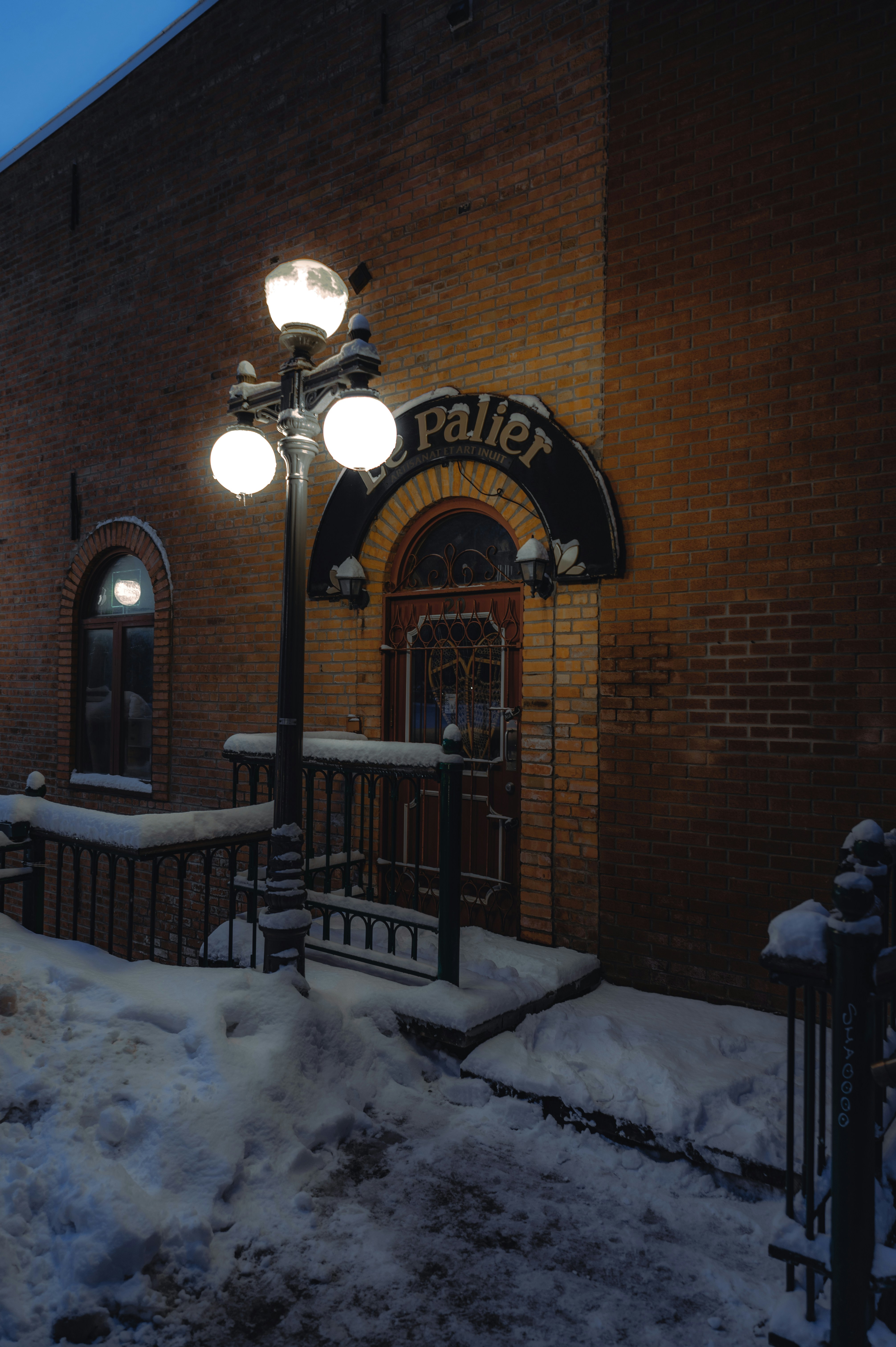 Winter Lanterns Framing a Historic Brick Entrance