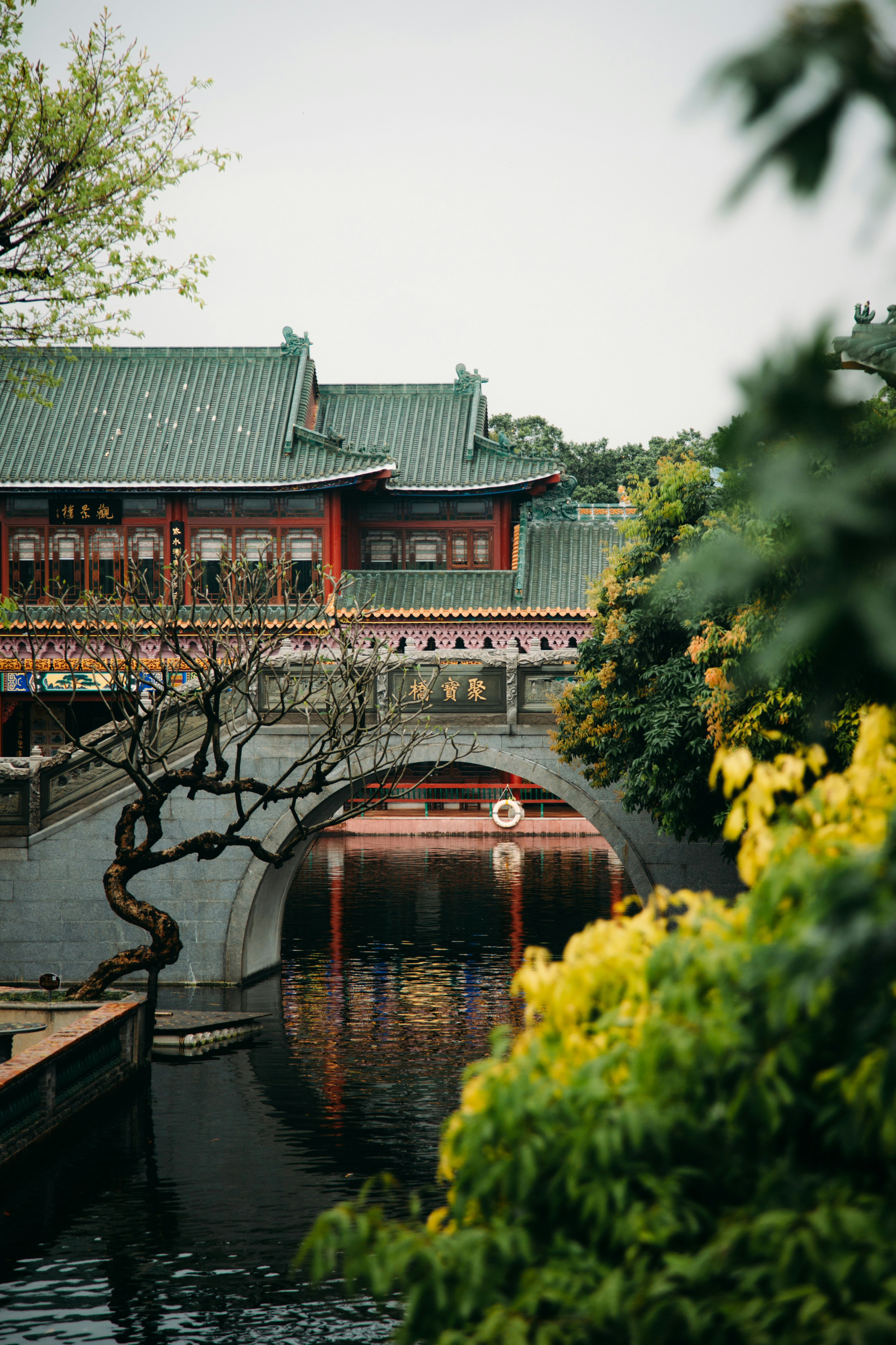 a bridge over a body of water with a building in the background