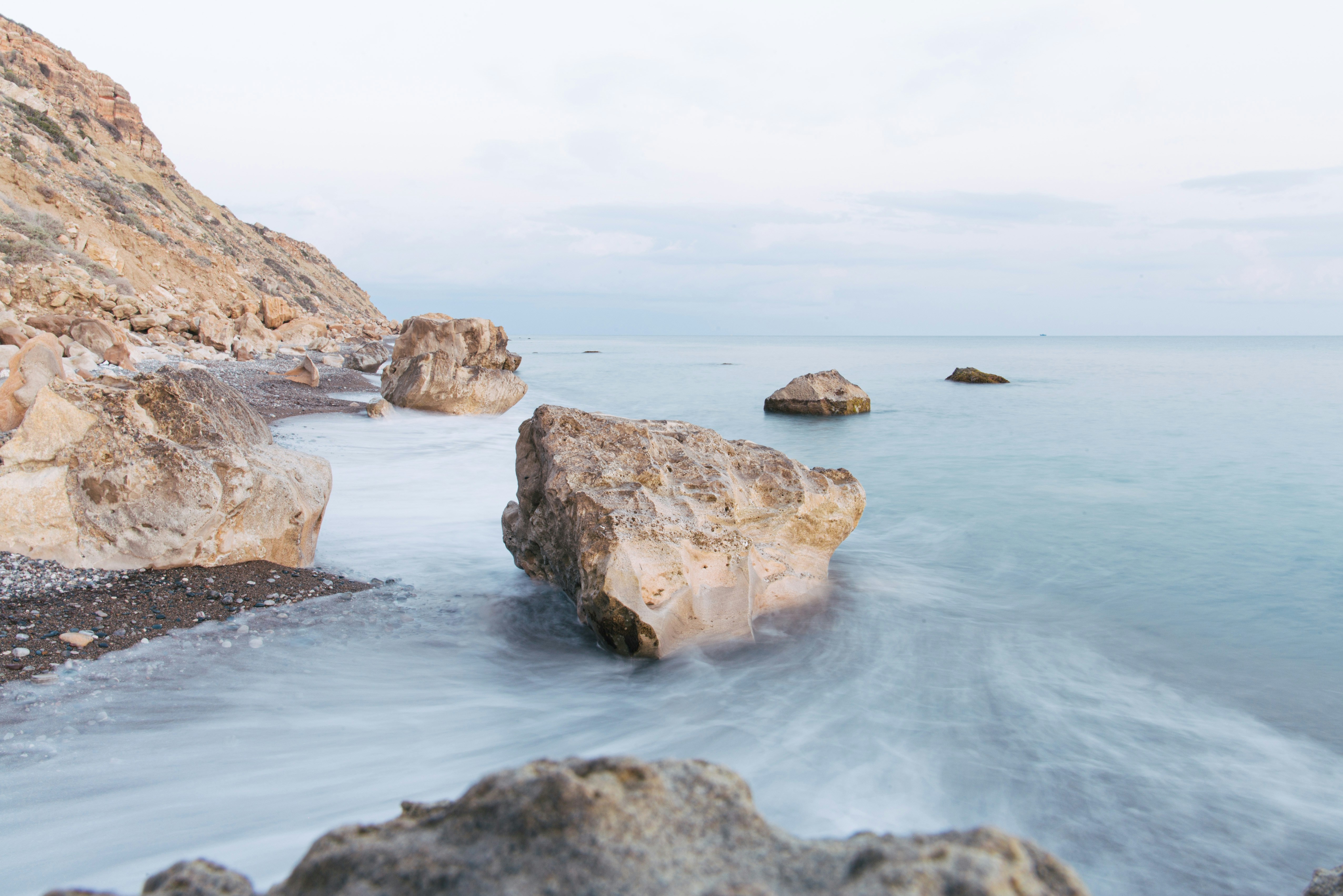 A body of water with rocks in it photo – Free Sea Image on Unsplash