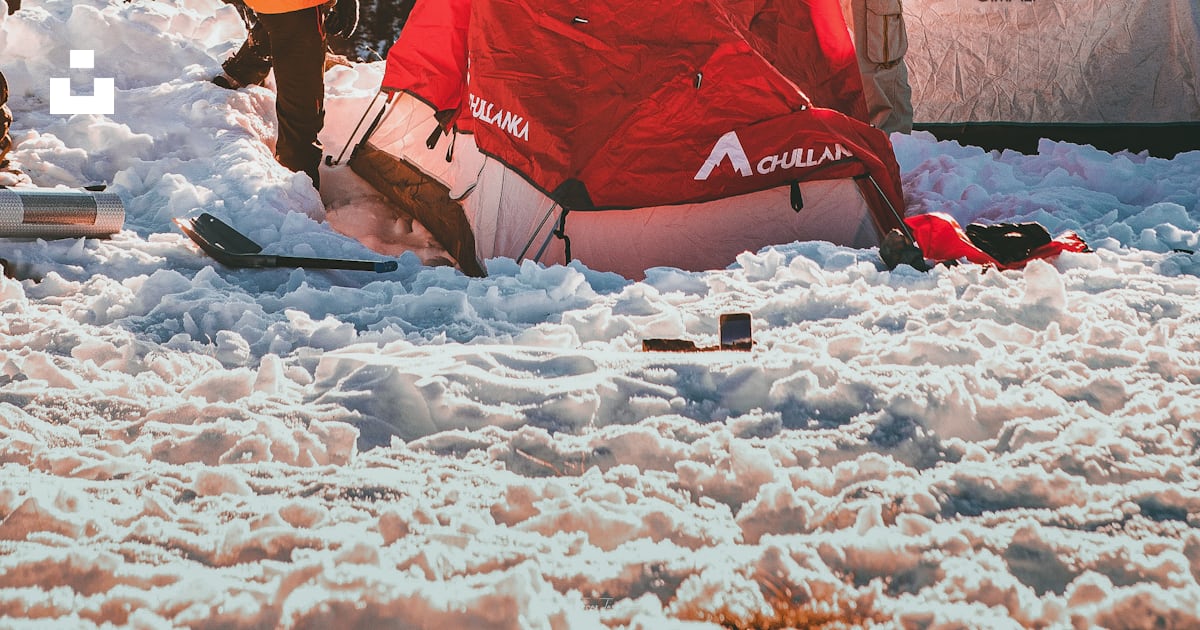 Un Groupe De Personnes Debout Autour Dune Tente Dans La Neige Photo