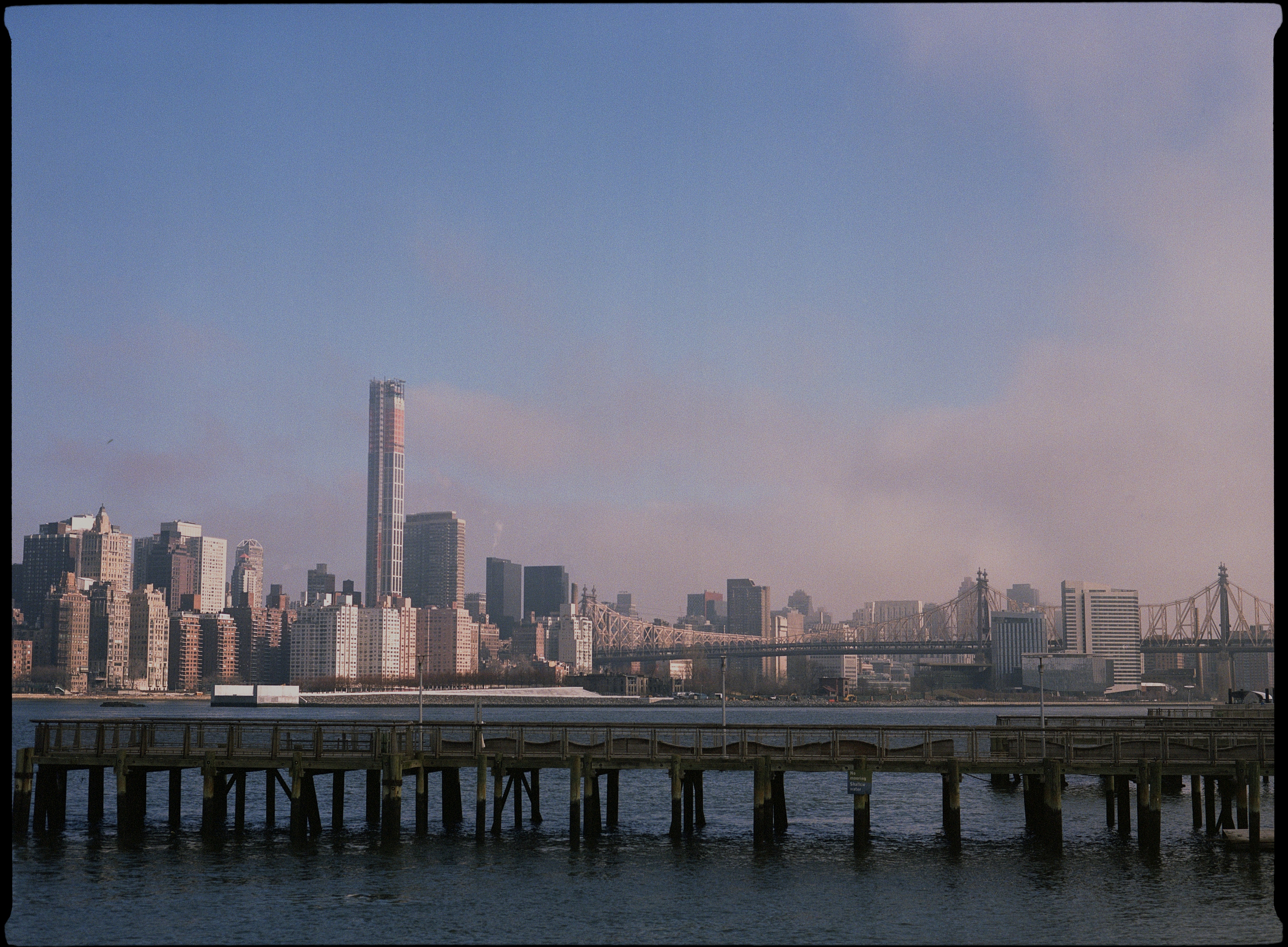 Pier and Skyline Glow Over a Quiet Harbor