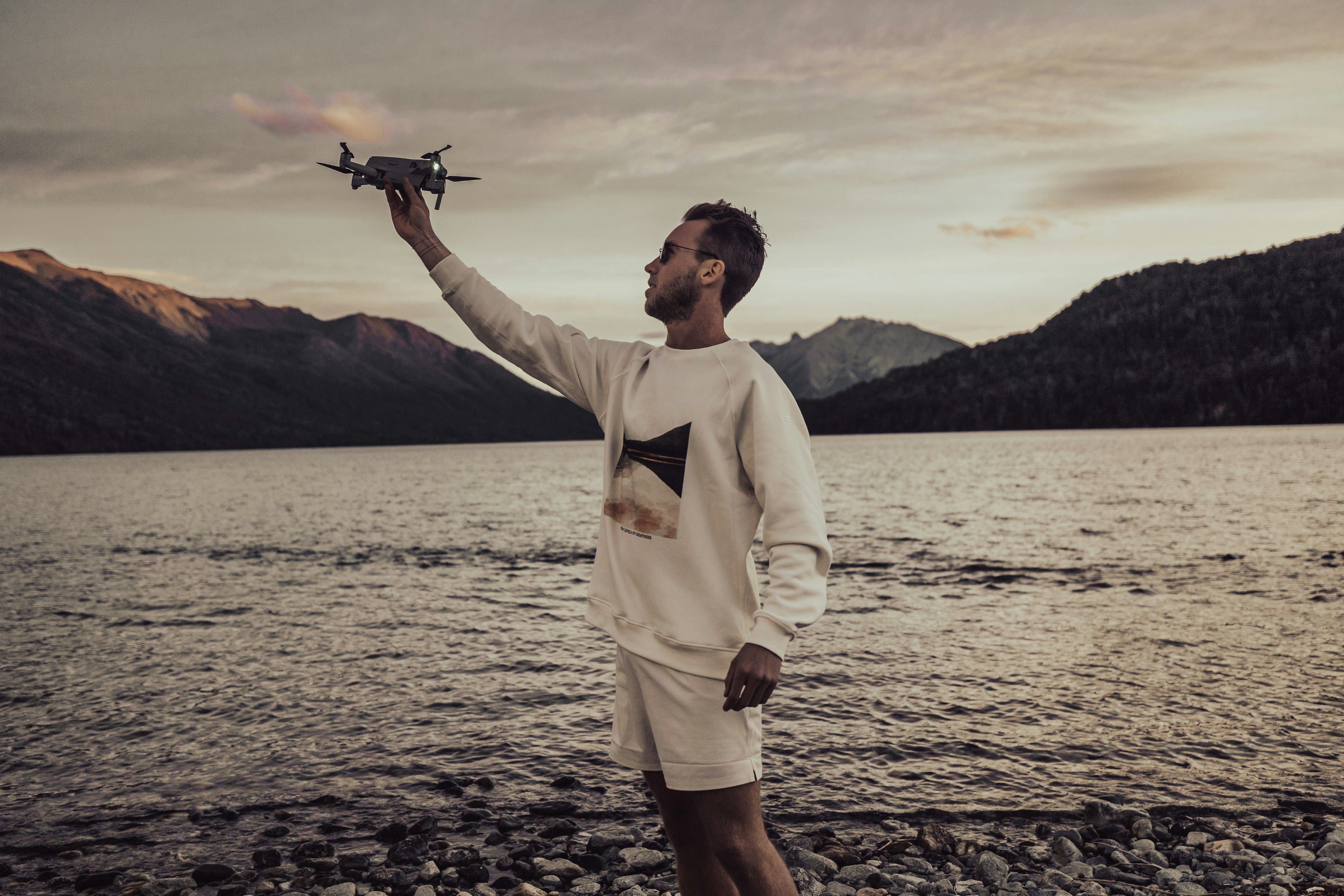 Holding High: A Drone Launch by the Lake