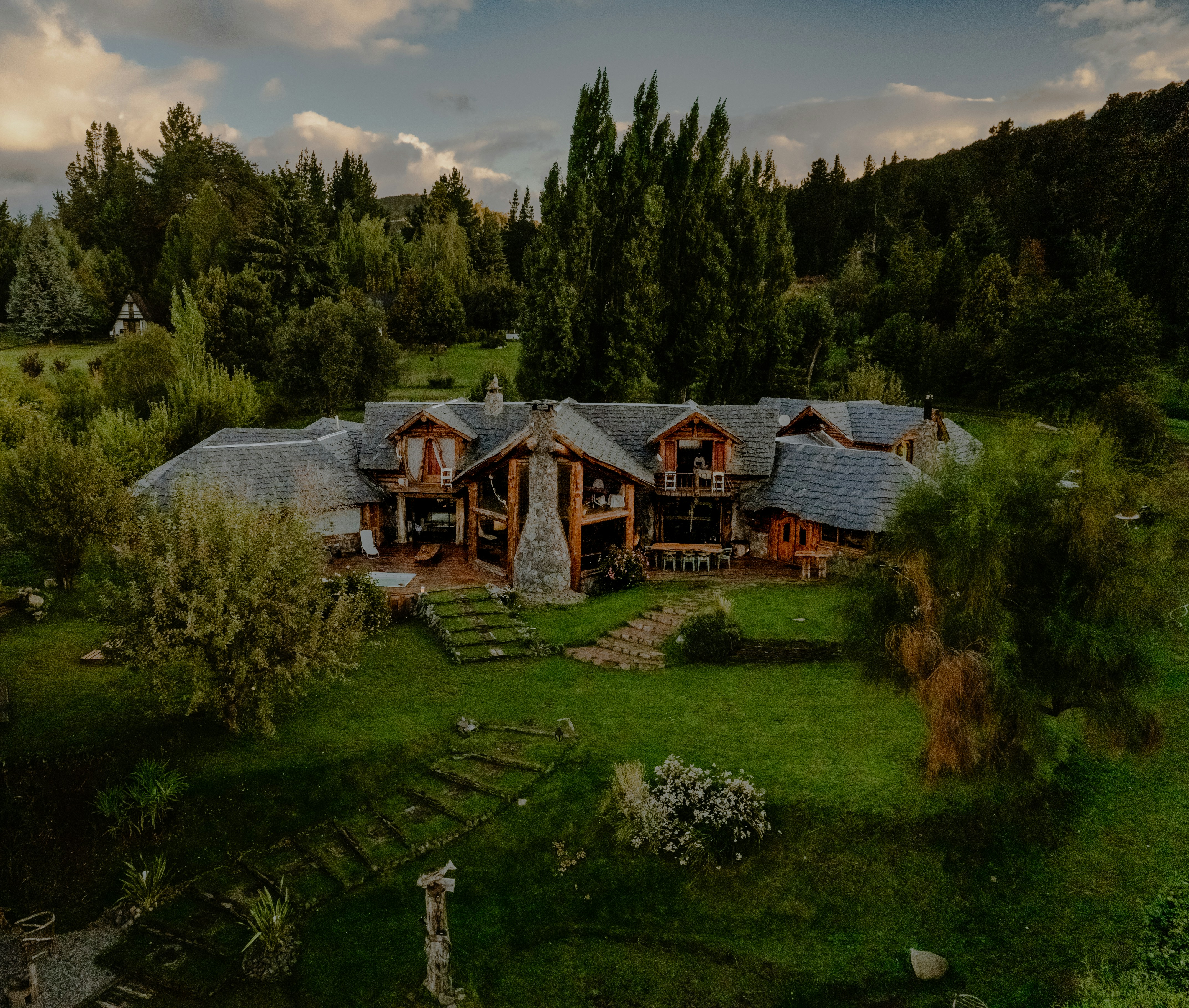 Evening at a Cedar Lodge: A Stone-Chimney Retreat Amid Tall Pines