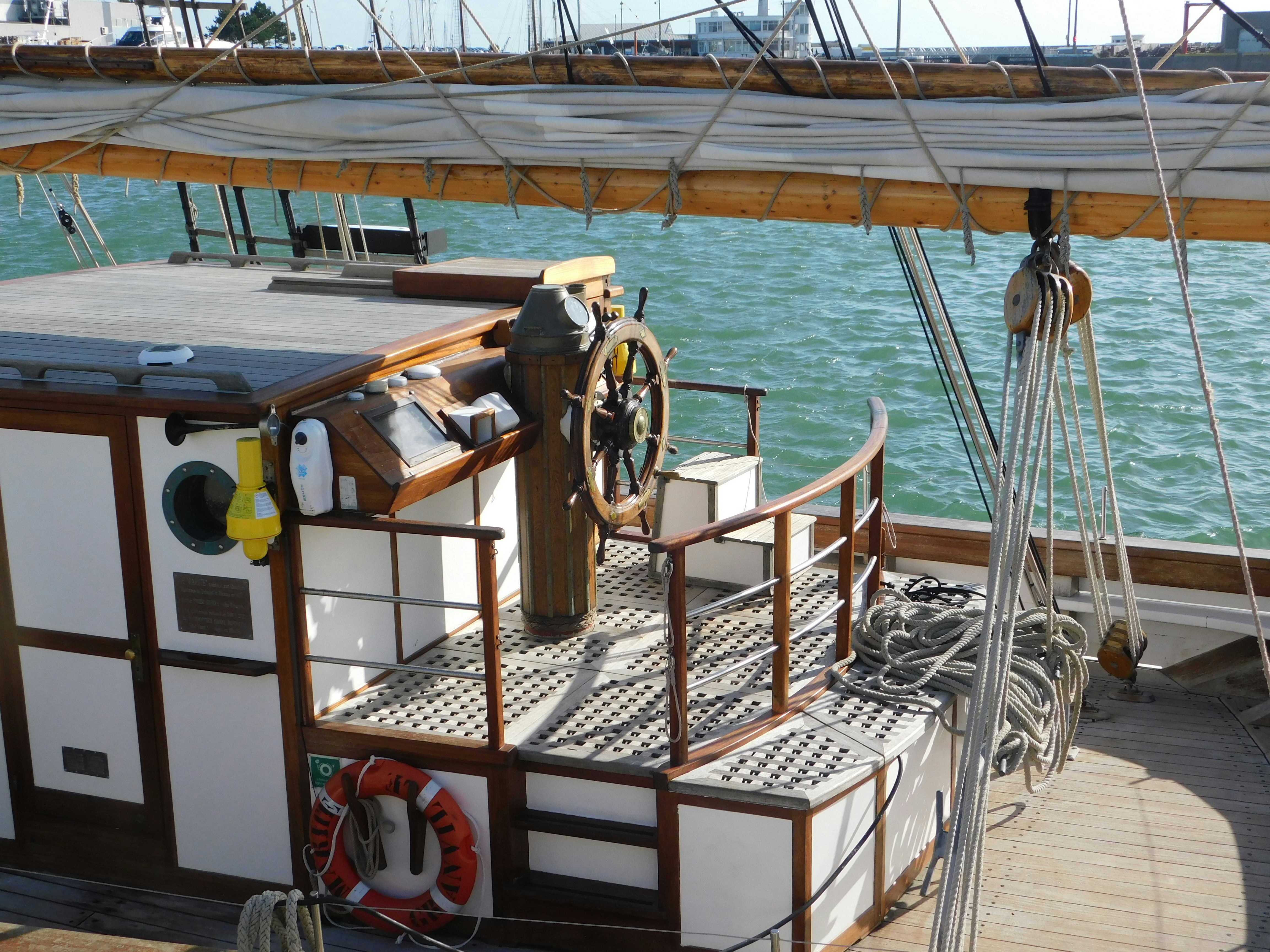 The Helm in Sunlit Balance: A Classic Sailboat's Command Deck