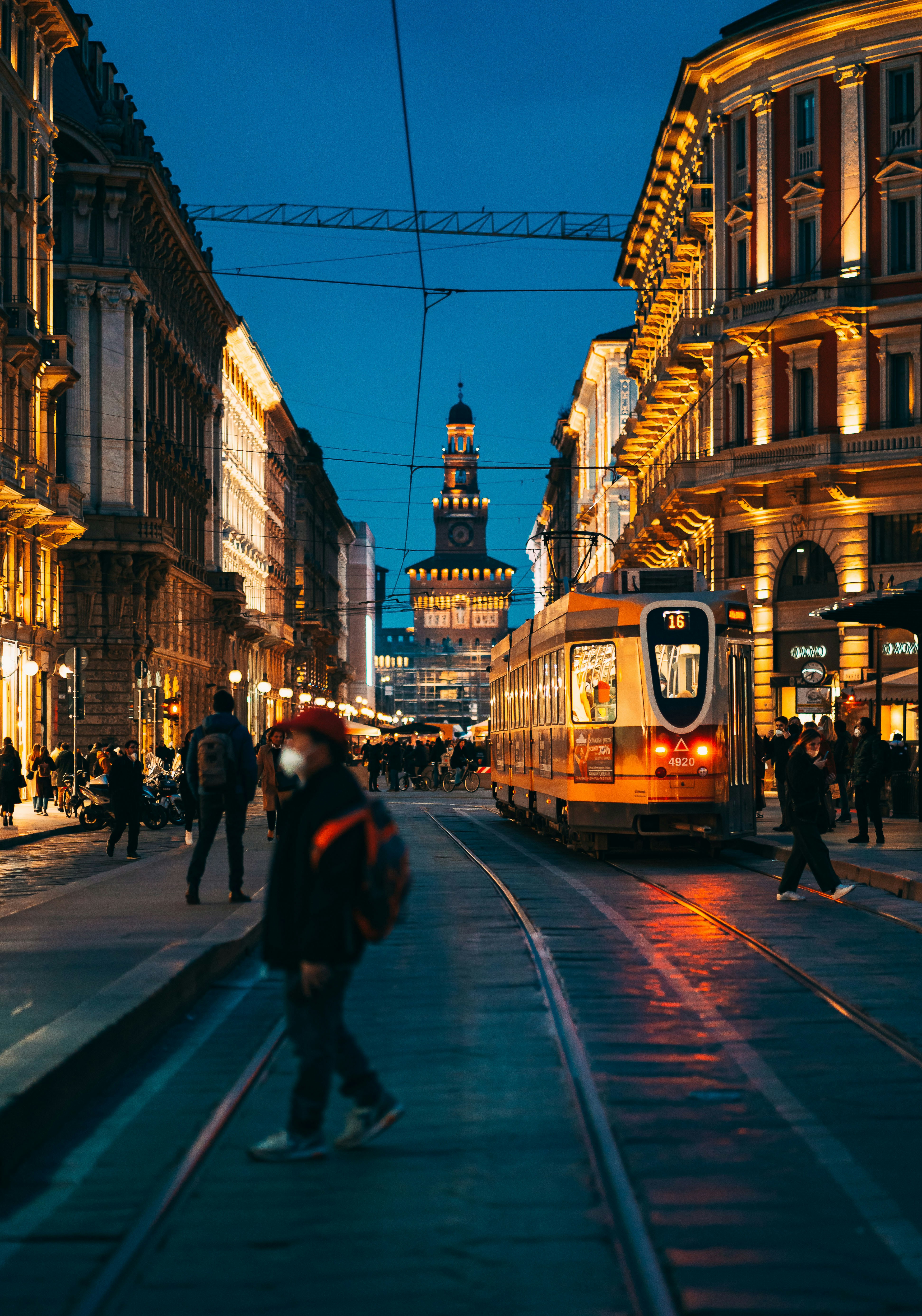 For any use contact me on Instagram (@gianp.anto_photo) | a person walking on a sidewalk next to a train on a street