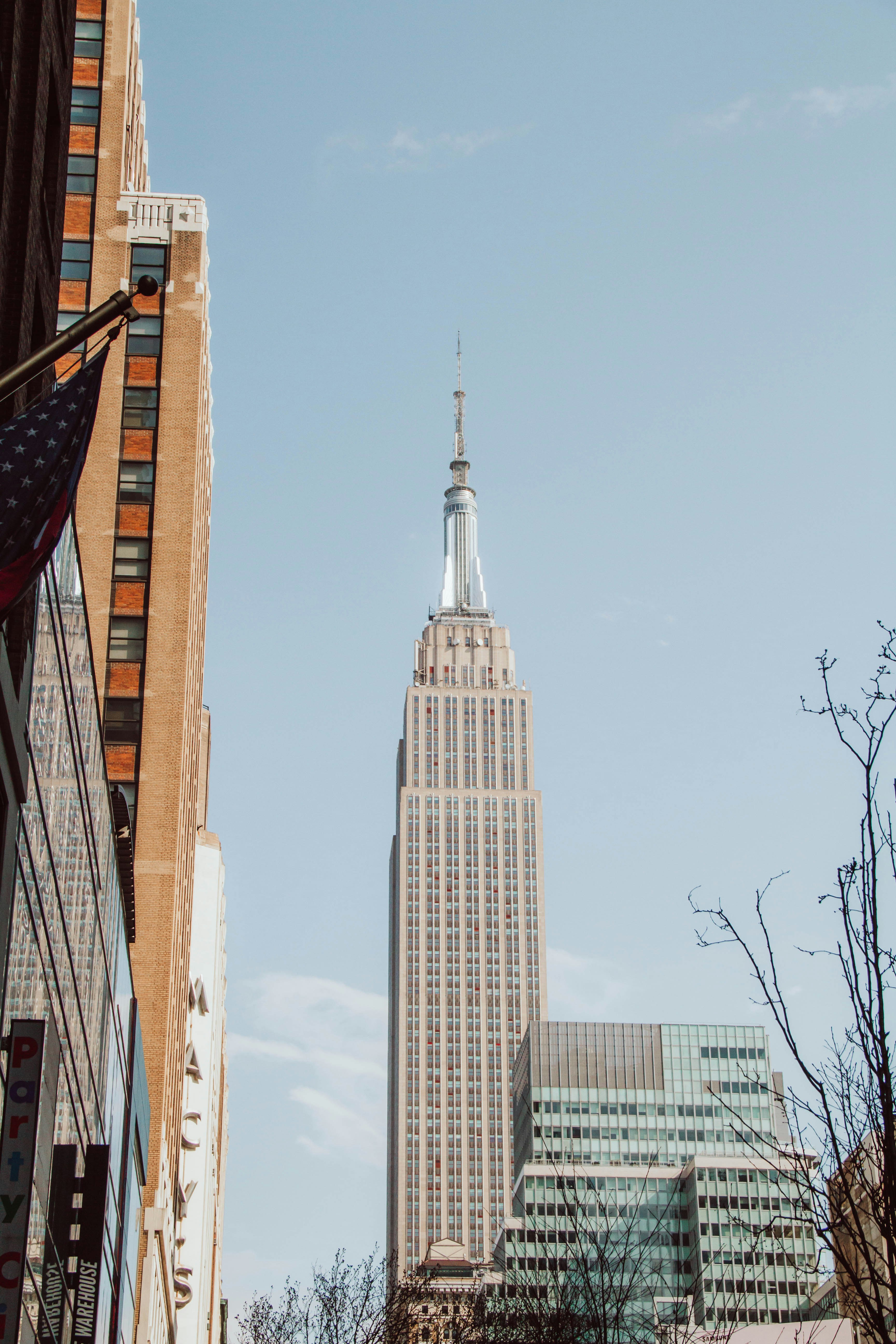 A tall building with a pointy top with Empire State Building in the ...
