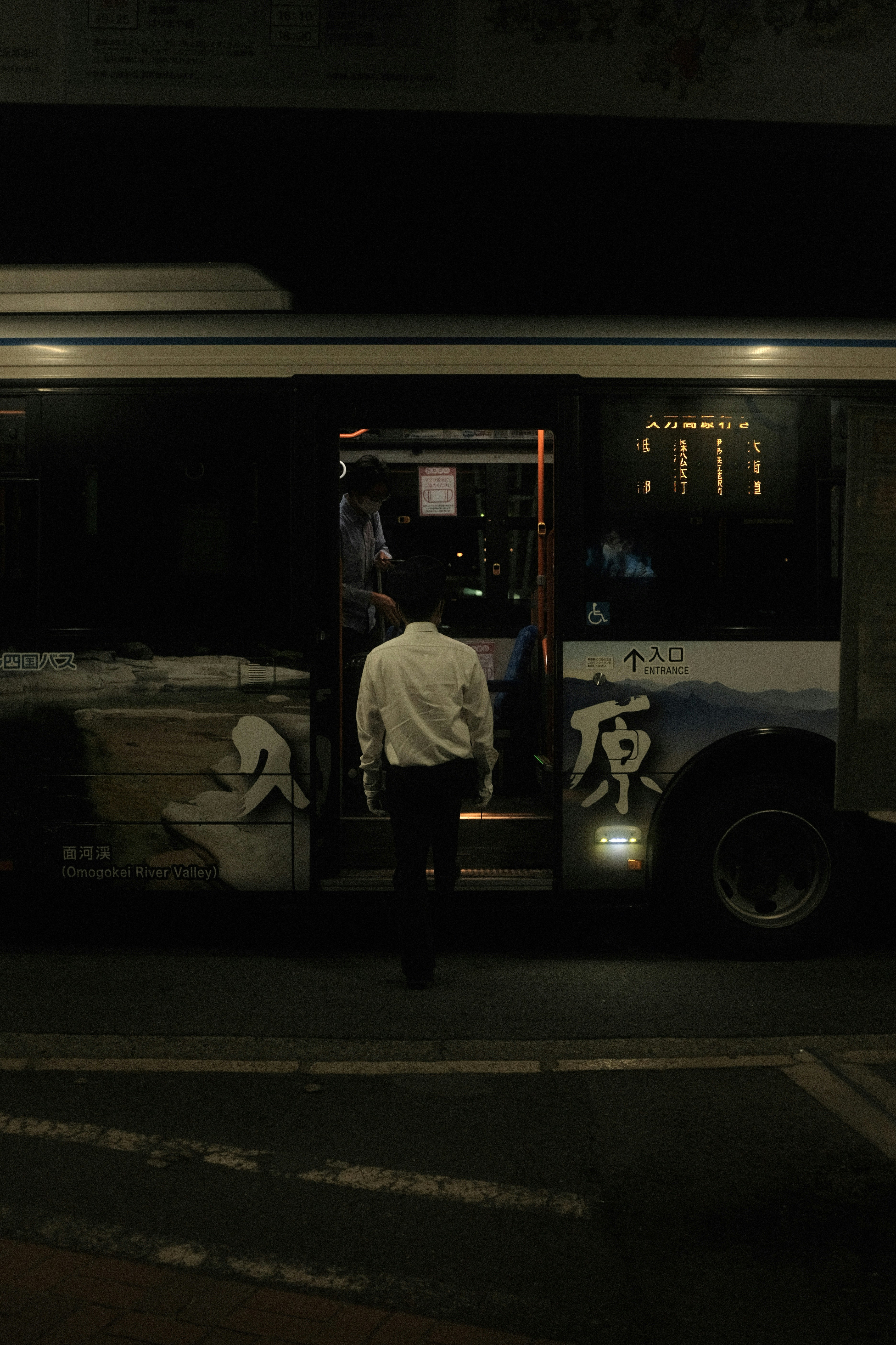 a man getting on a bus