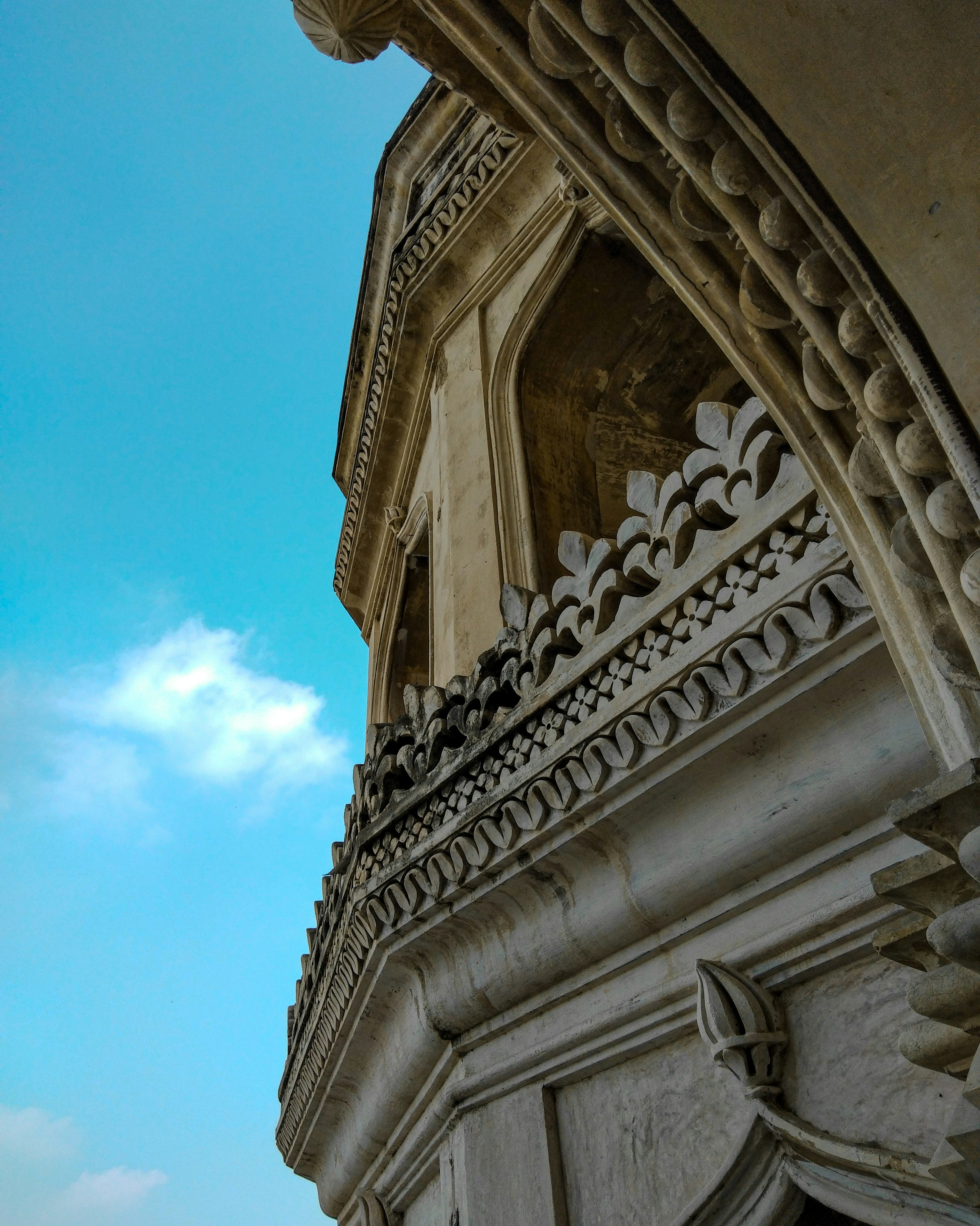 Ornate architectural details of a historical building against a clear blue sky.