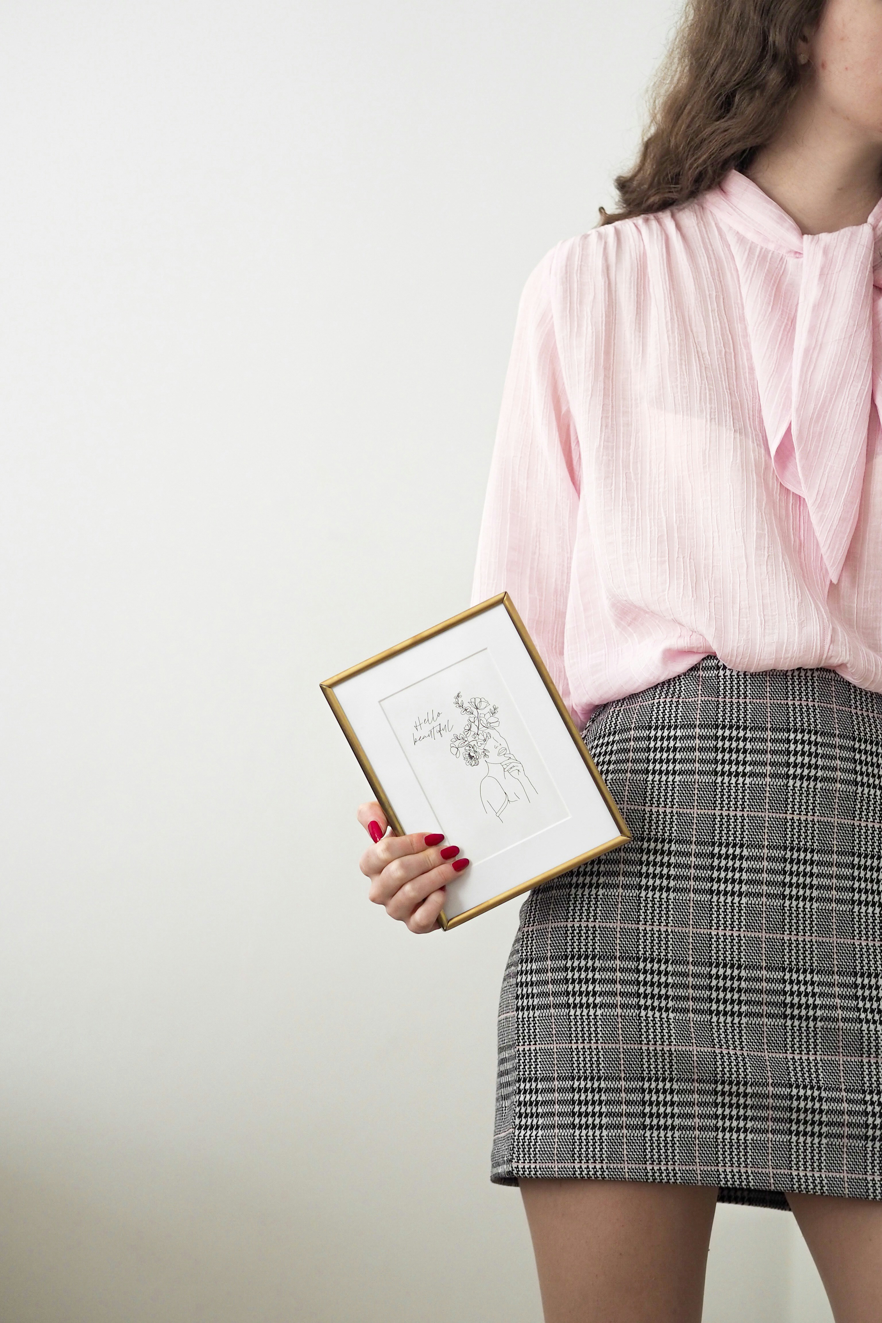 Framed Whisper: A Pink-Blouse Moment with a Handheld Sketch