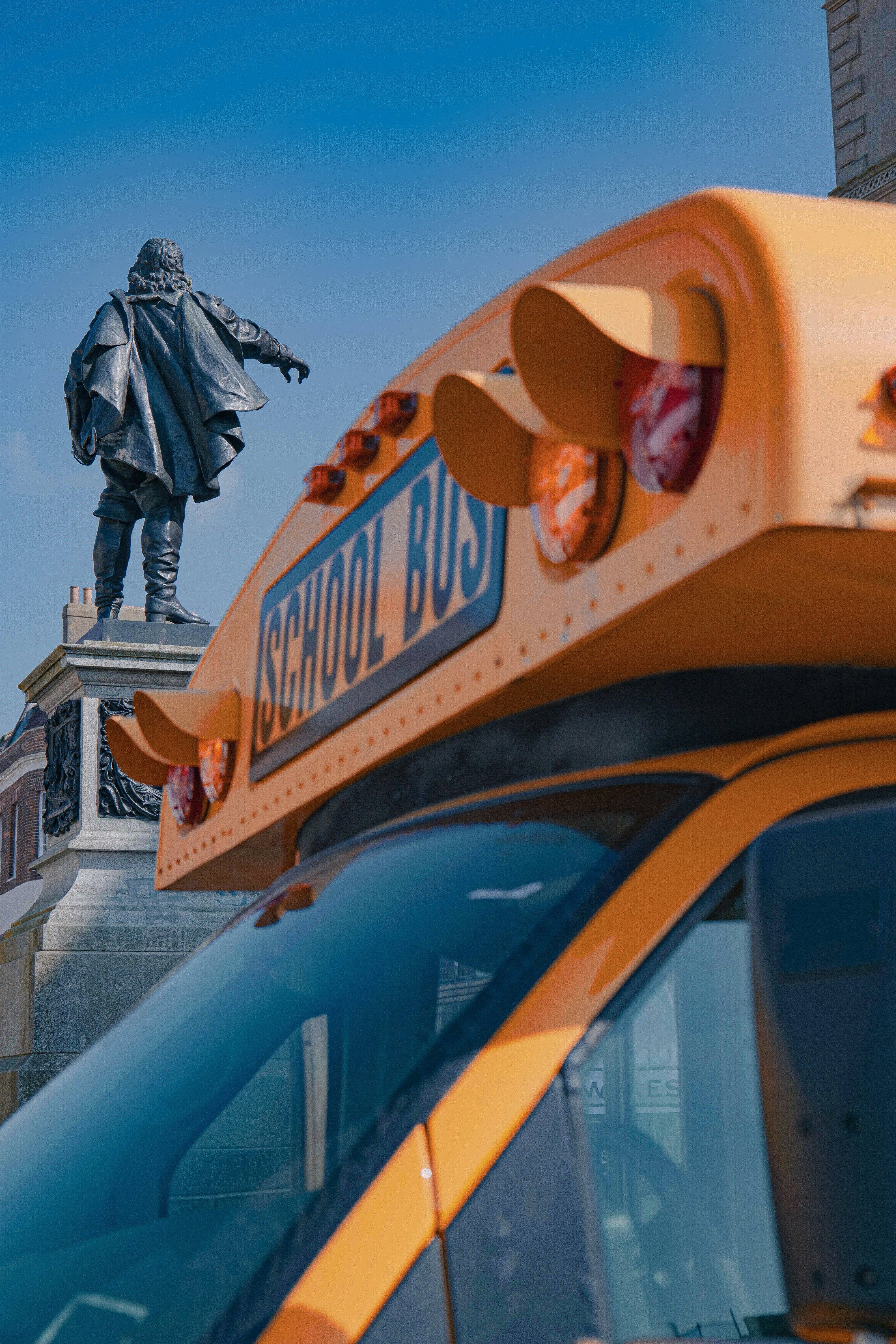 Bronze Pioneer and the Bus: A City Street Portrait