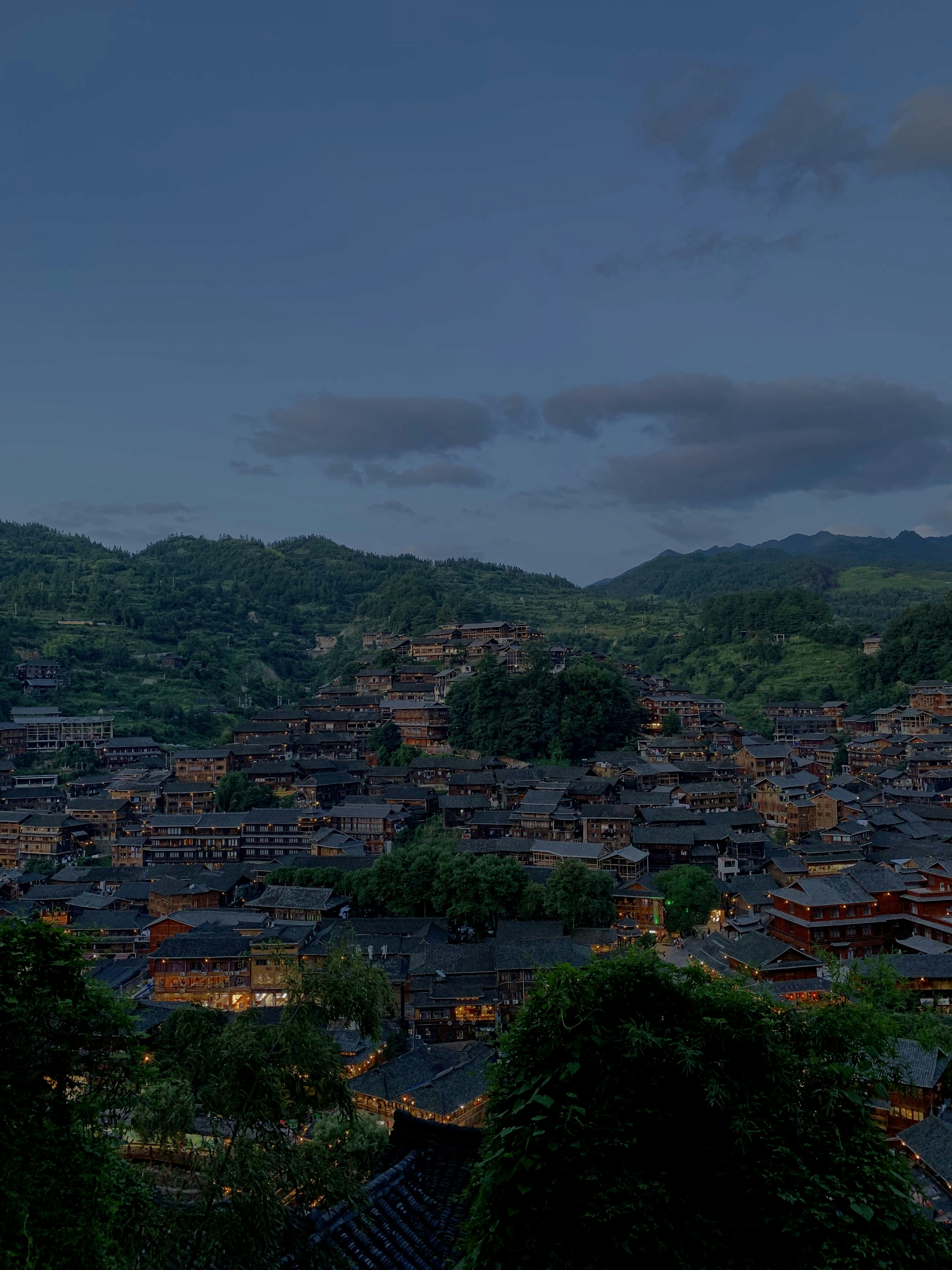 Dusk Over a Terraced Mountain Village Illuminated by Evening Lights