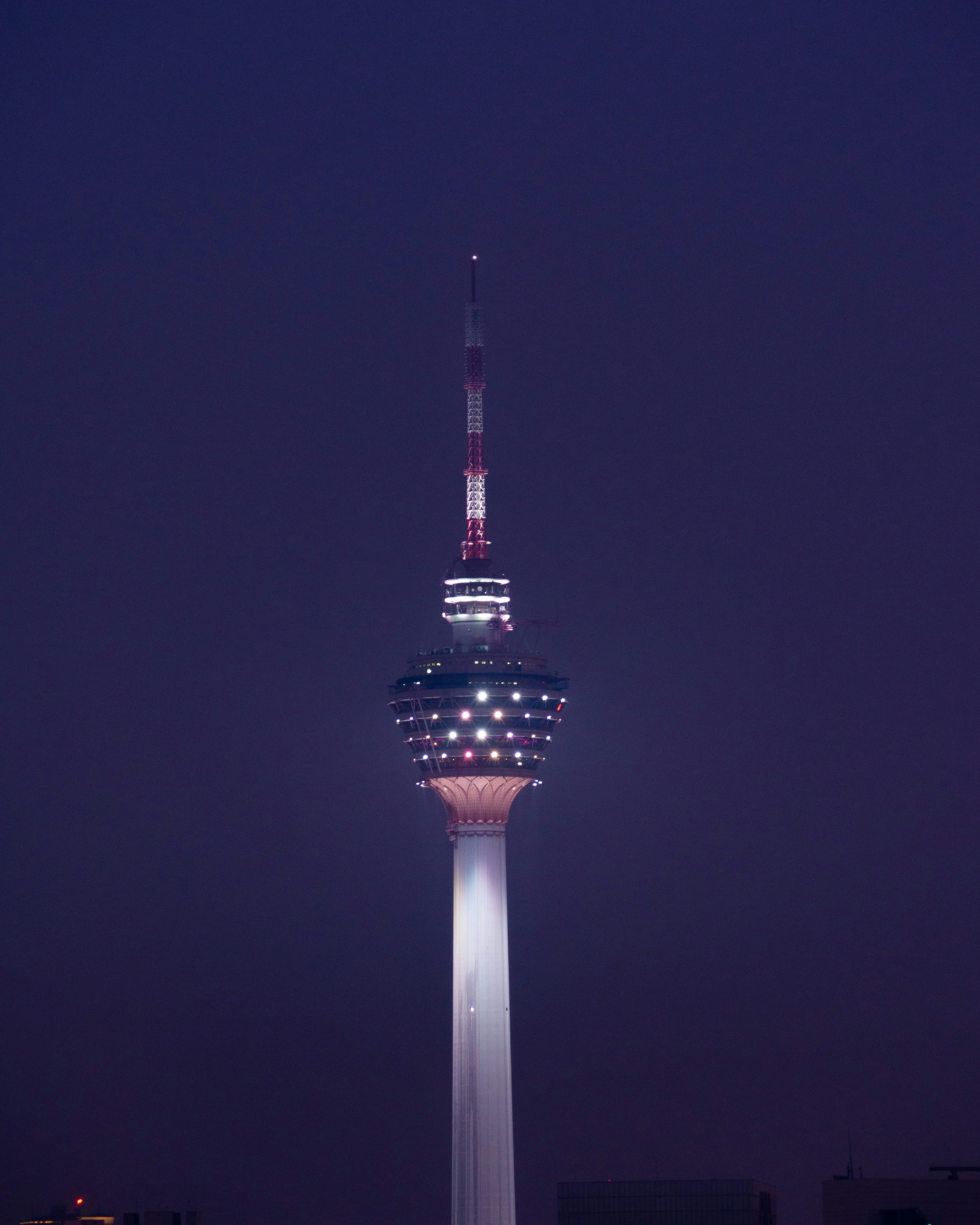 A towering observation deck radiating lights against a twilight backdrop. The structure stands tall, showcasing its architectural elegance.