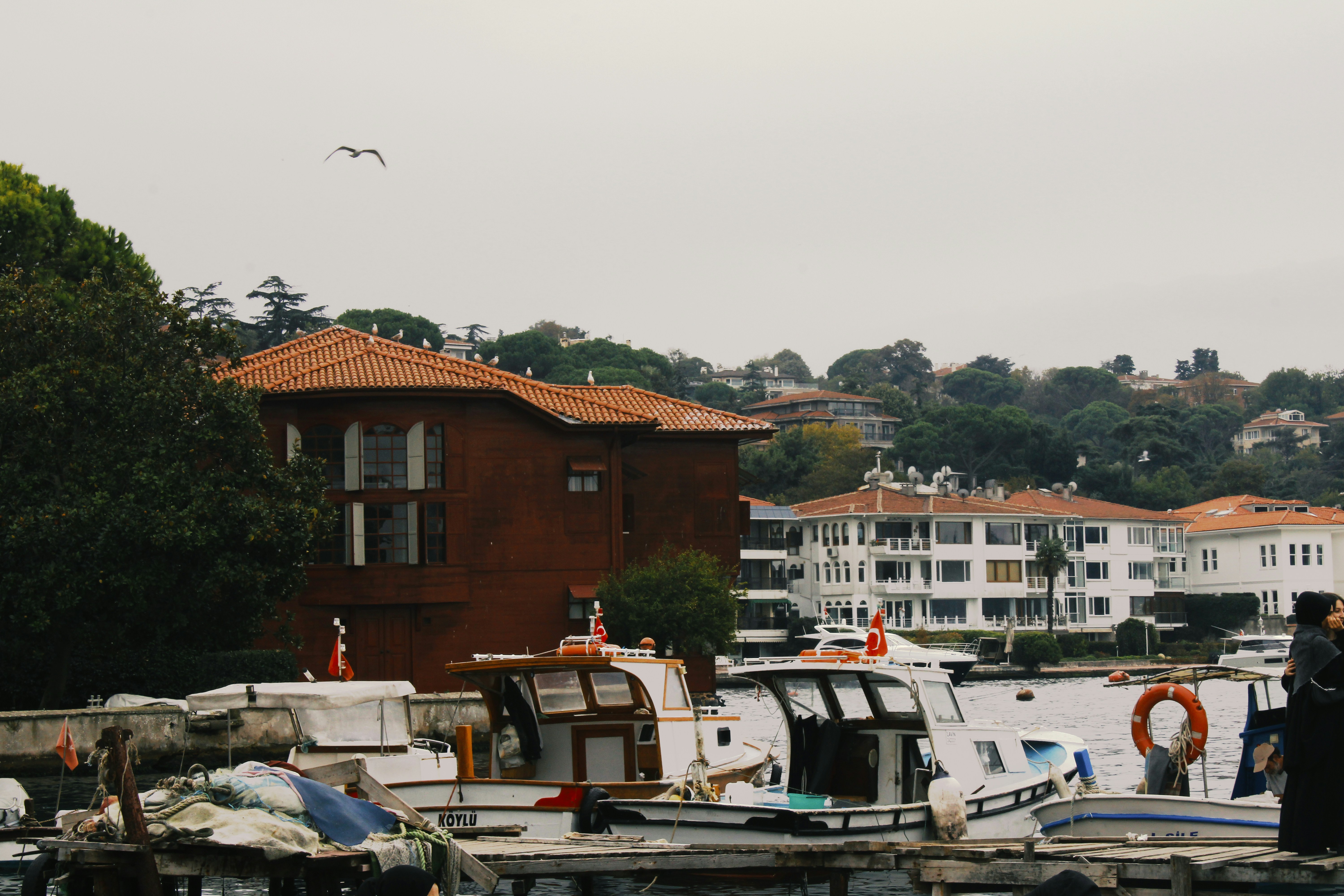 Red-Brick Harbor: Boats at the Quay Beneath a Calm Coastal Skyline